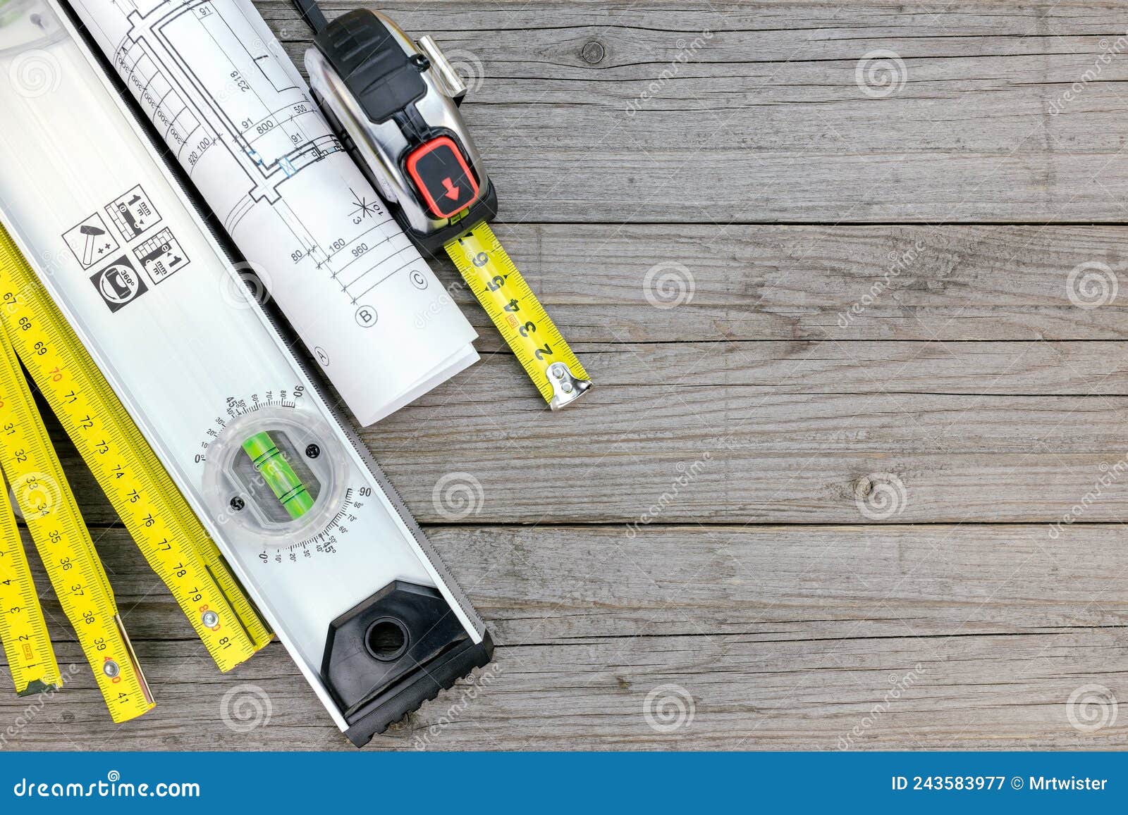 Blueprint Rolls with Tape Measure and Folding Rule on Wooden Table ...