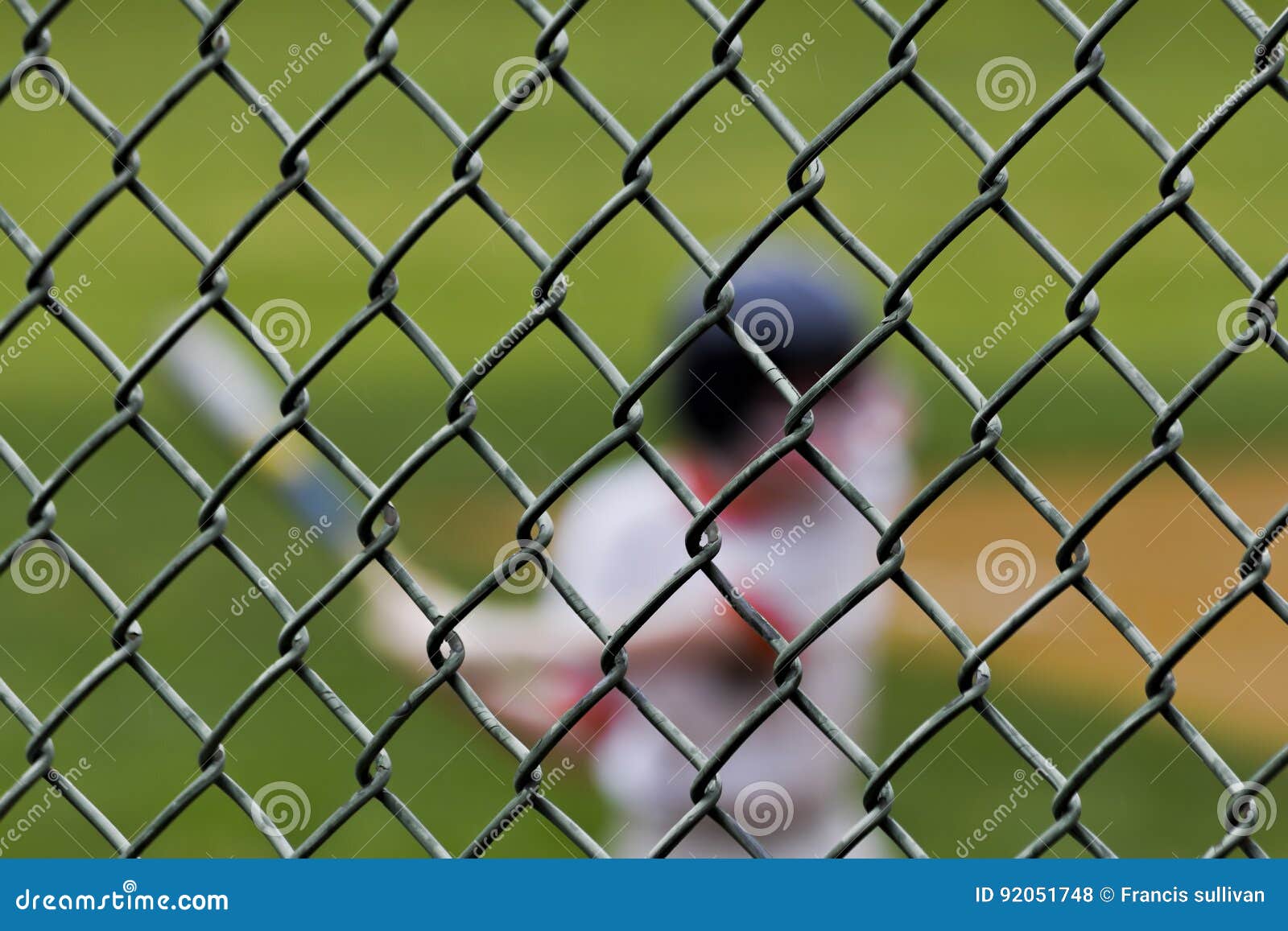 Blurred Baseball Player Behind Fence Stock Photo - Image of grass ...