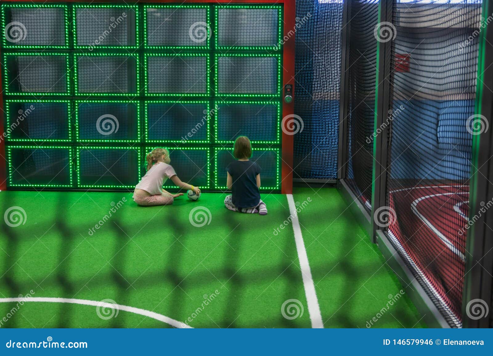 Blurred Children are Playing Behind the Net at Indoor Playground in ...
