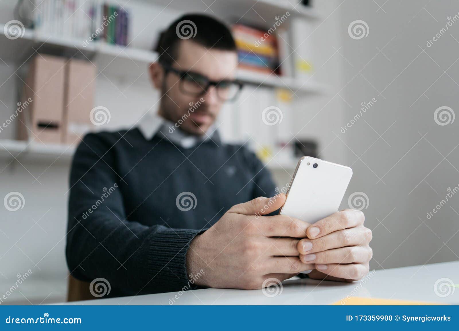 Blurred Man Holding on Focus Phone in Office Stock Photo - Image of ...
