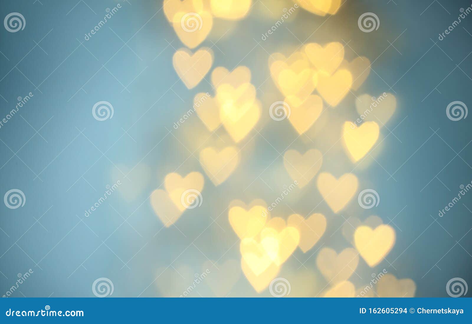 Blurred View of Beautiful Gold Heart Shaped Lights on Blue Background ...
