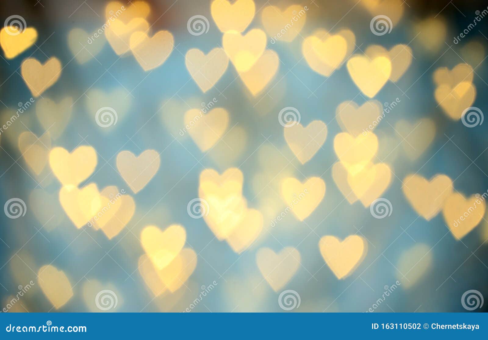 Blurred View of Beautiful Gold Heart Shaped Lights on Blue Background ...