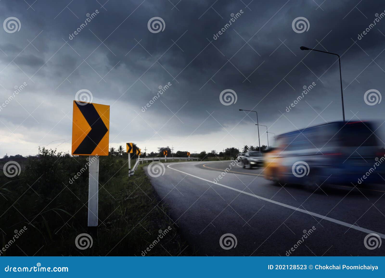 Blurry Car Running through Sharp Curve with Arrow Warning Signs Stock ...