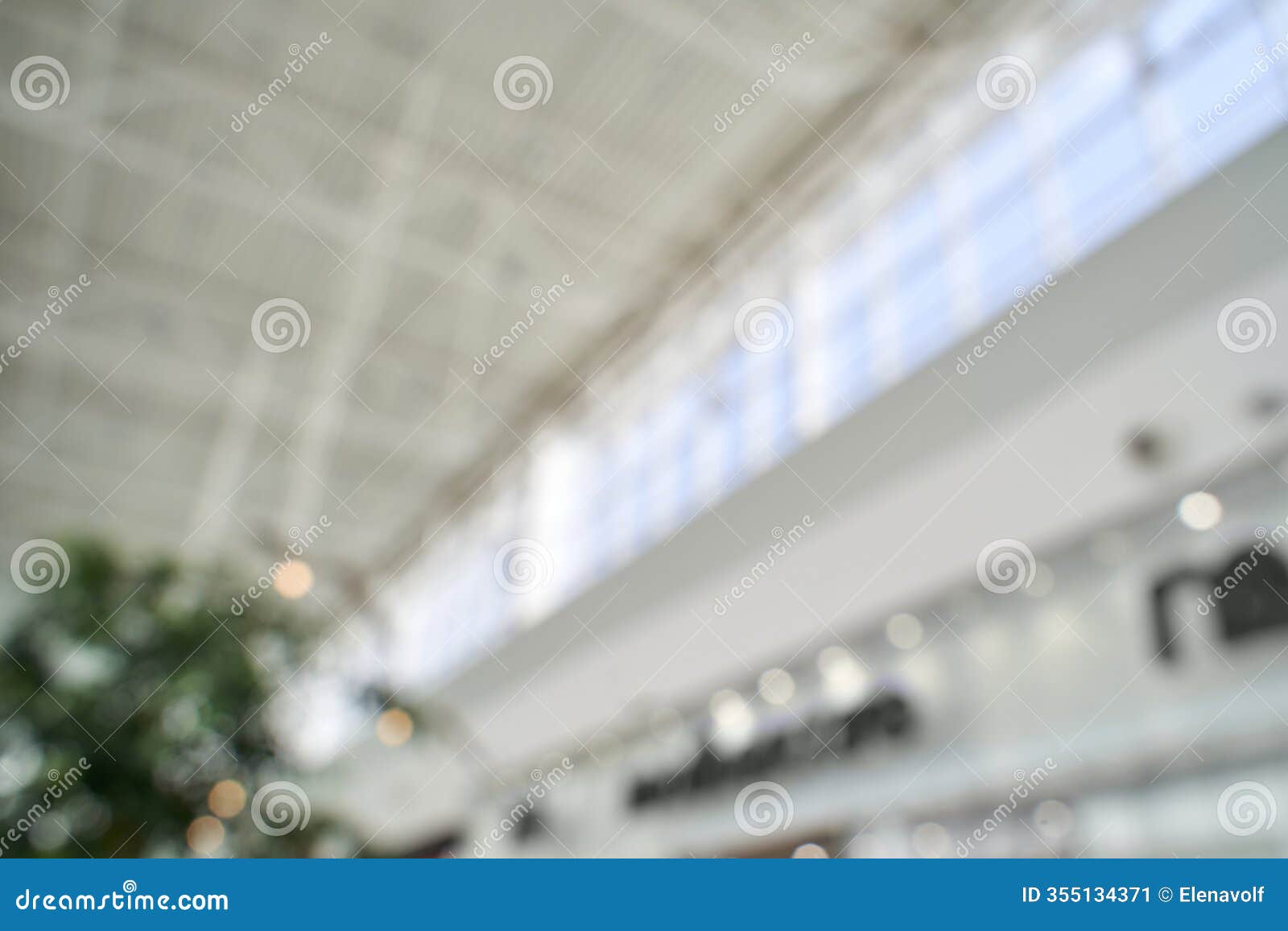 Blurry Interior View of a Modern Shopping Mall with High Ceilings and ...