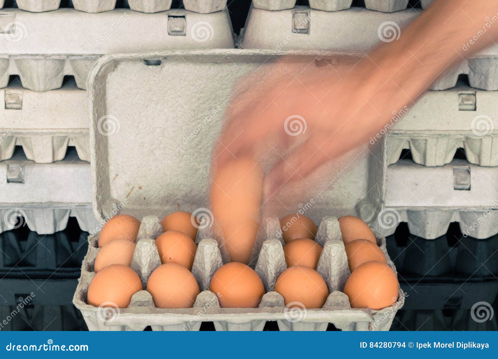 Blurry Man Hand Picking Up an Egg from Egg Box Stock Photo - Image of ...