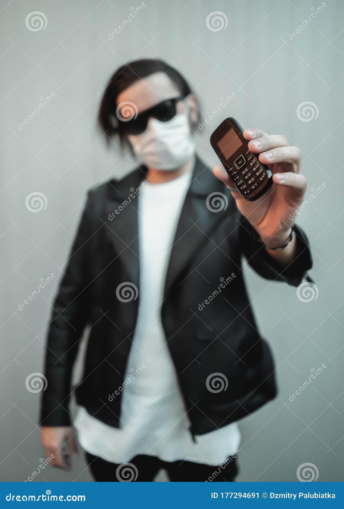 A Blurry Man in a Protective Mask Holds a Phone Stock Image - Image of ...