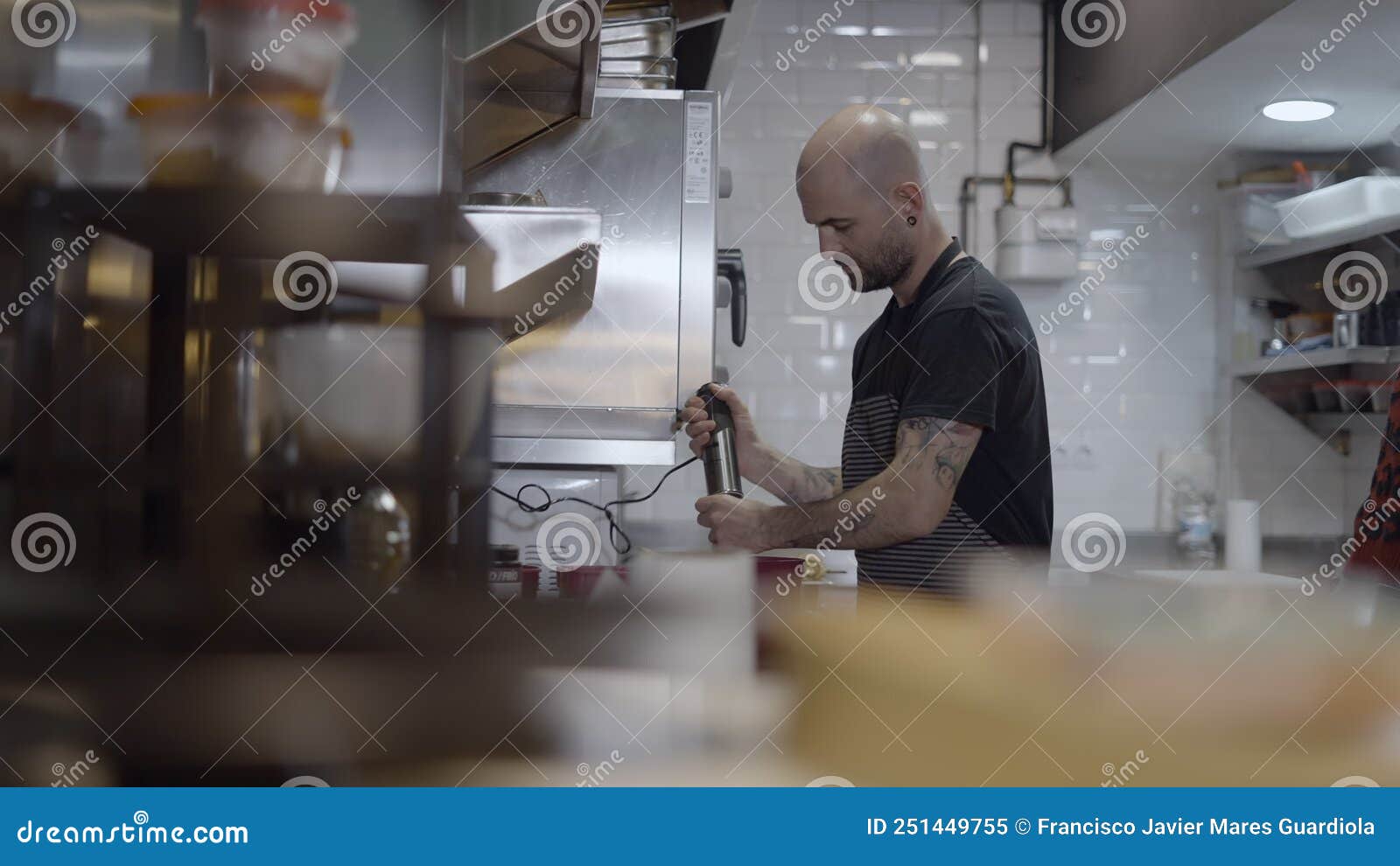 Blurry Objects in Foreground of Chef Working in Restaurant Kitchen ...