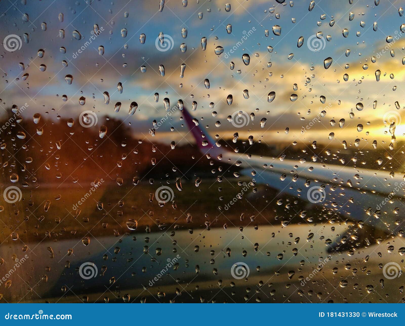 Blurry View of an Airport Runway through an Airplane Window with Rain ...