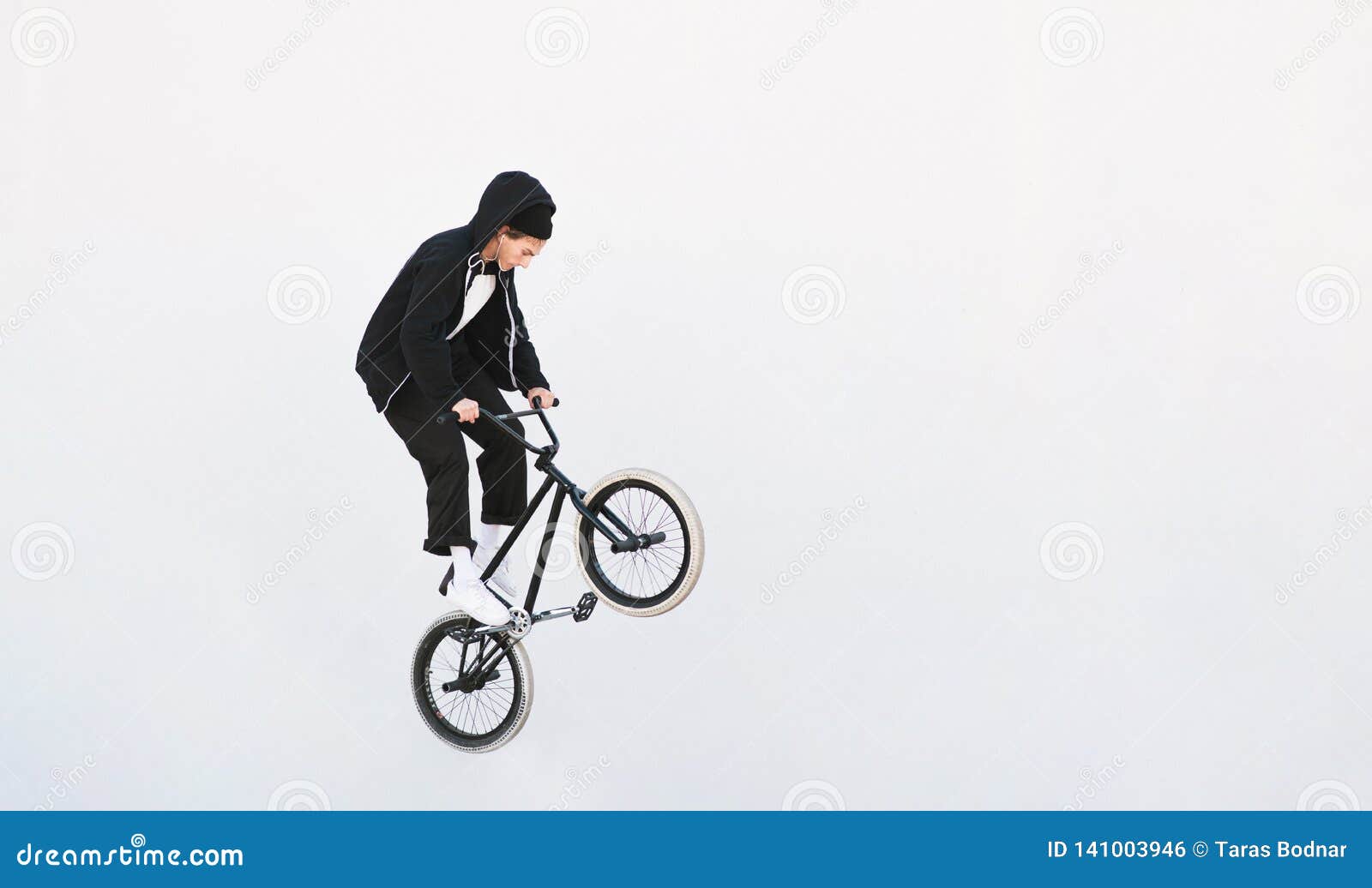Bmx Freestyle On The Background Of A White Wall. BMX Rider Makes A ...