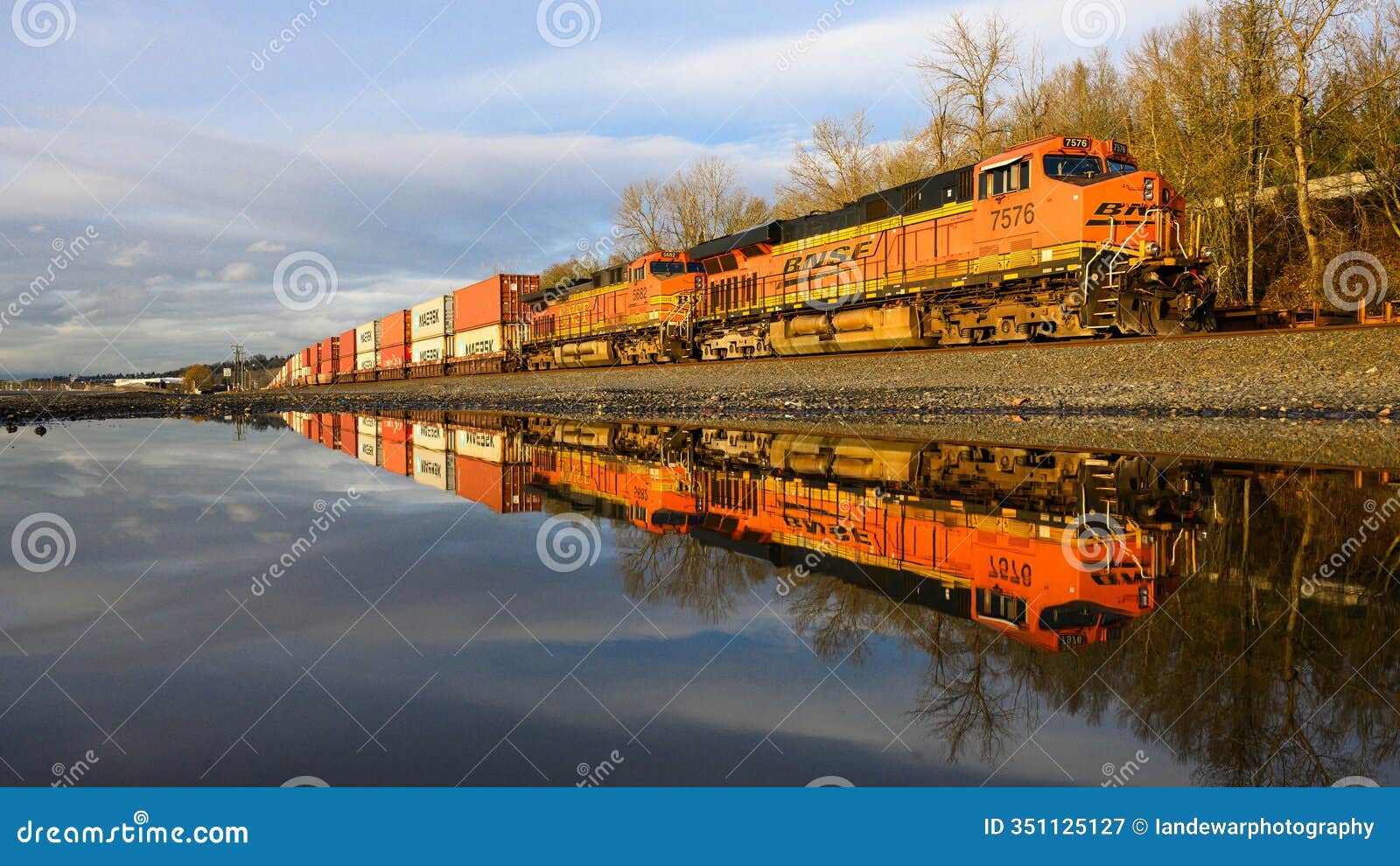BNSF Intermodal Container Feight Train Reflecting in Puddle in Golden ...