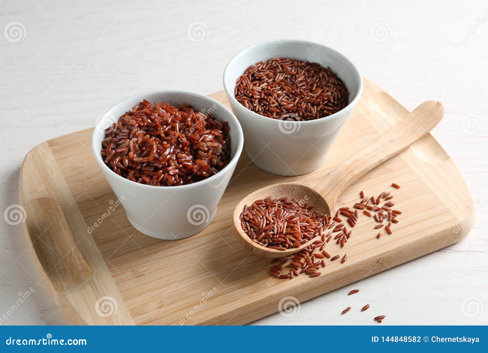 Board with Boiled and Uncooked Brown Rice on Table Stock Photo - Image ...