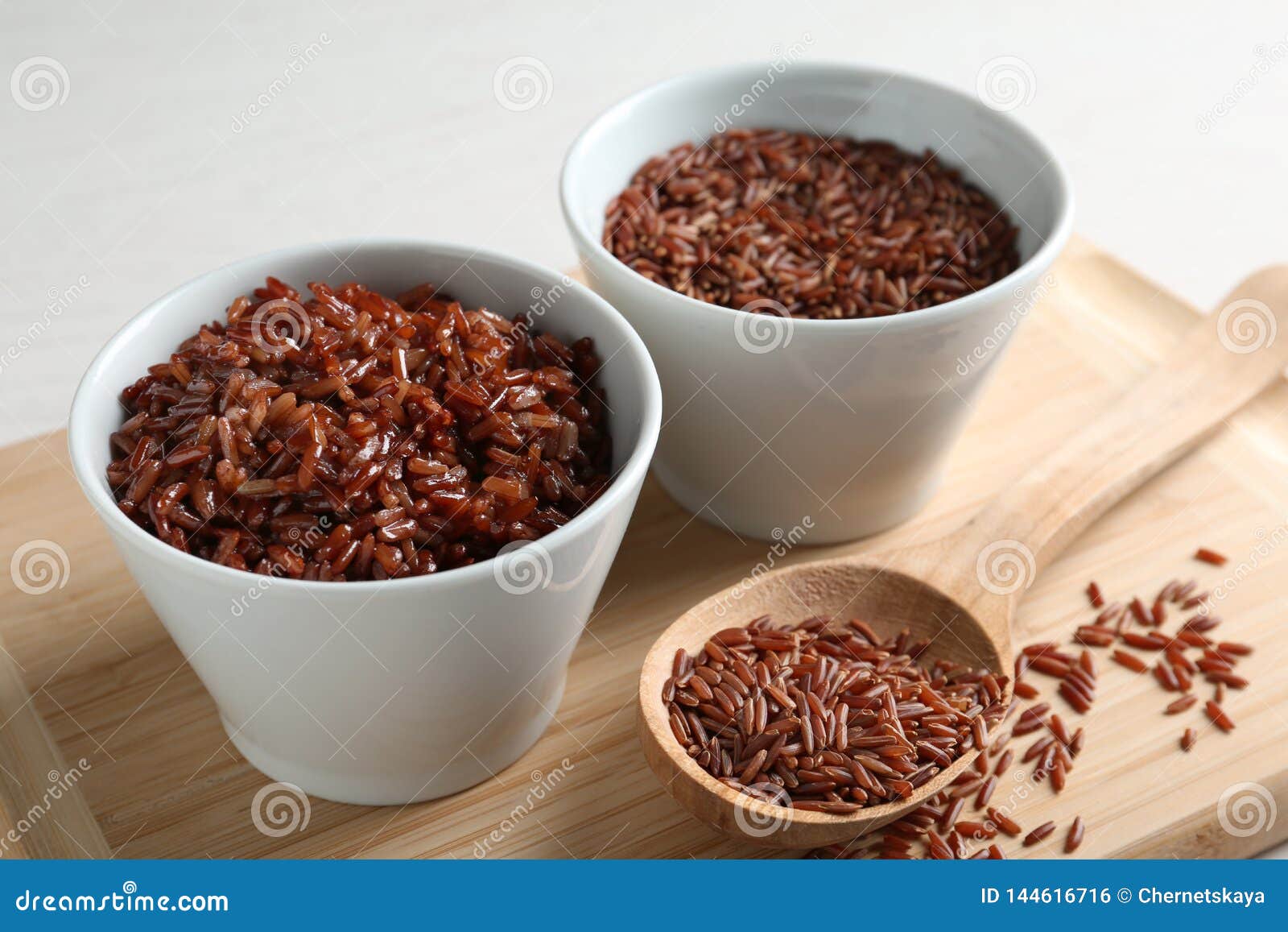 Board with Boiled and Uncooked Brown Rice on Table Stock Photo - Image ...