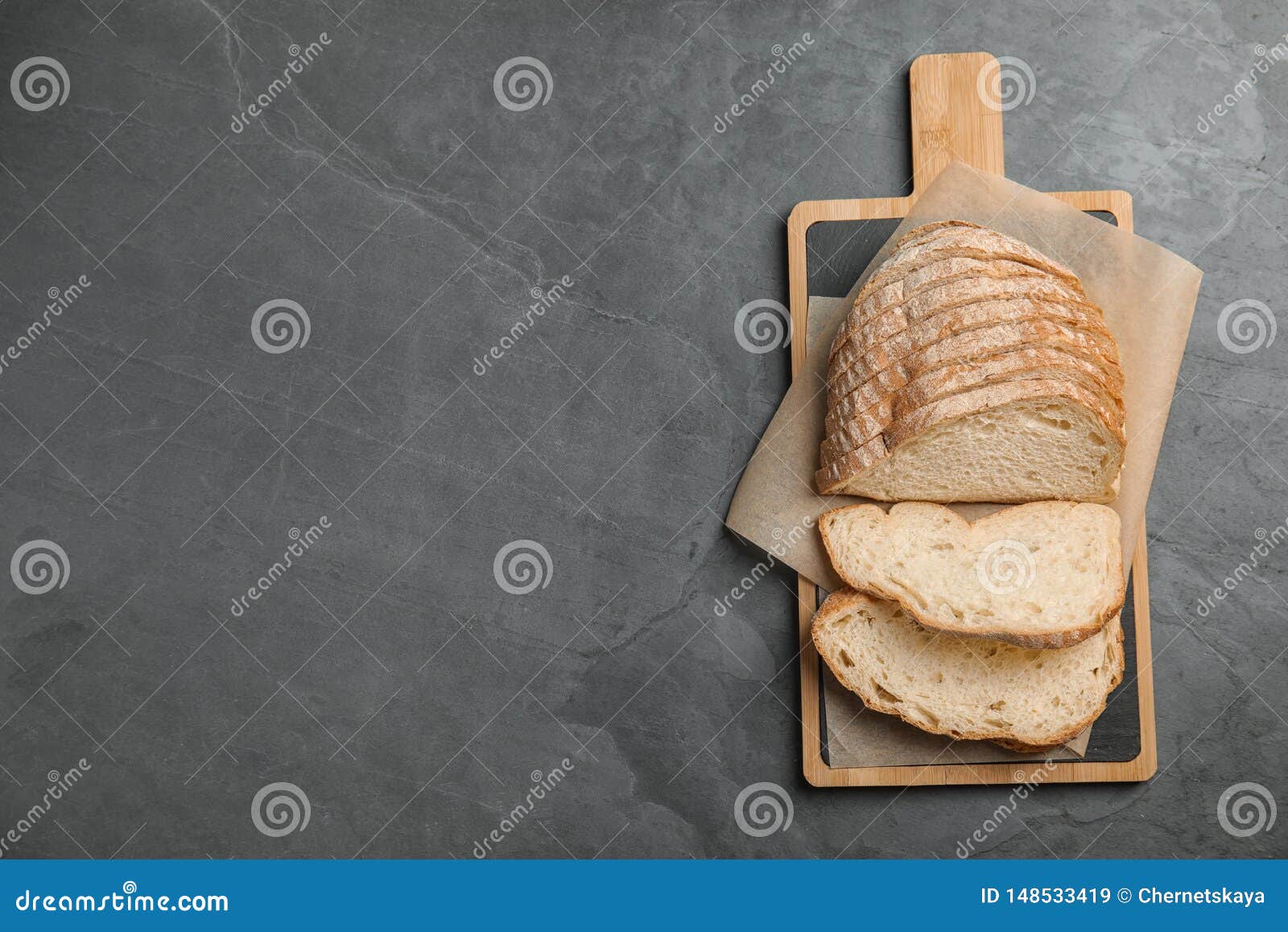 Board with Cut Bread on Grey Table. Space for Text Stock Image - Image ...