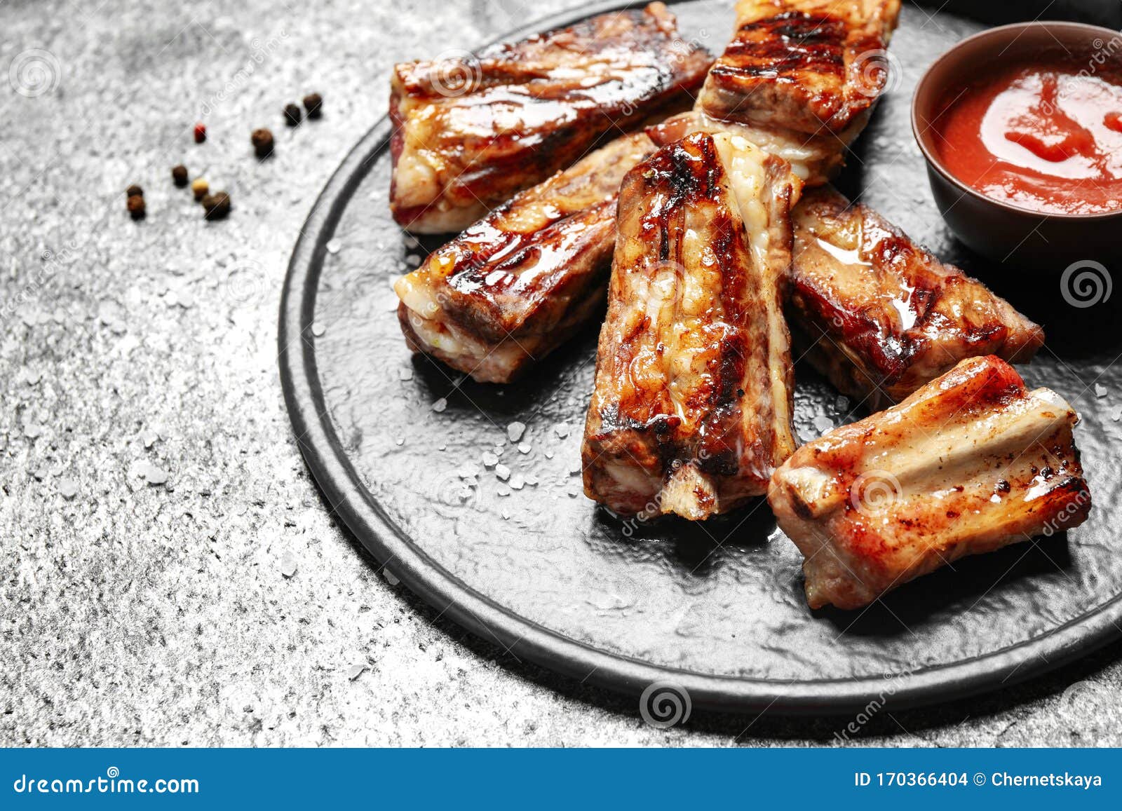 Board with Delicious Ribs on Grey Table, Closeup Stock Photo - Image of ...