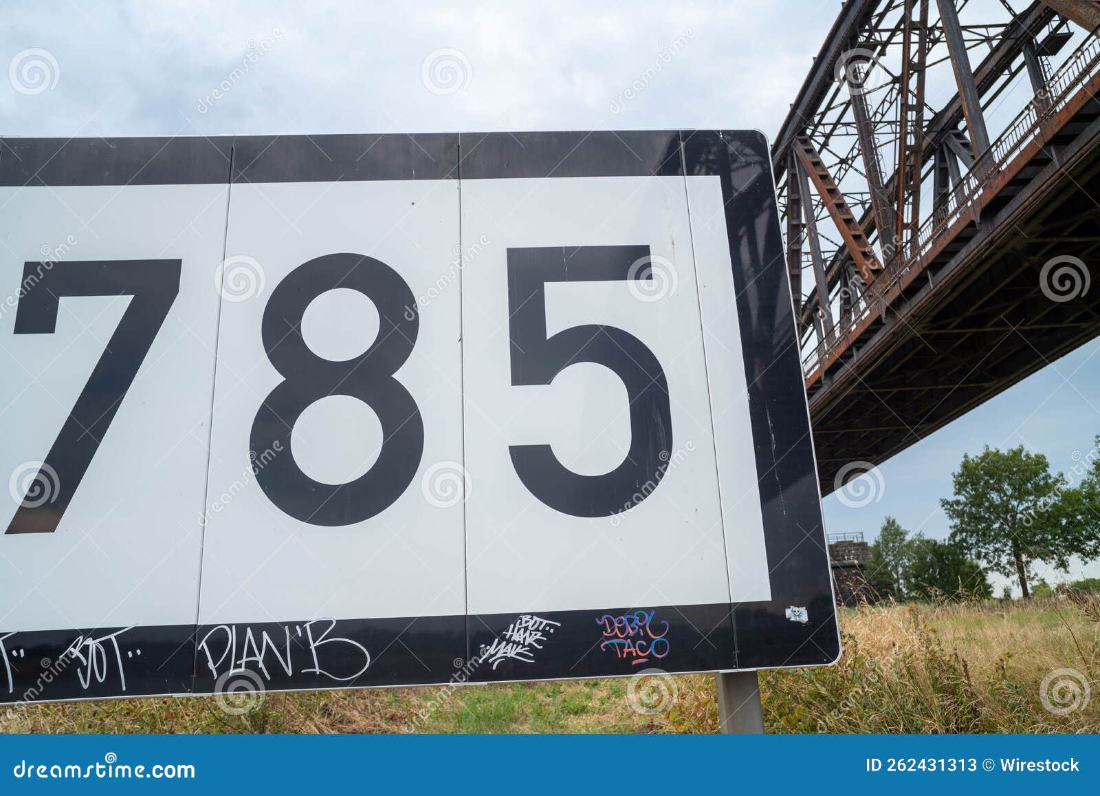 Board with a Number 785 Under a Bridge Stock Image - Image of grass ...