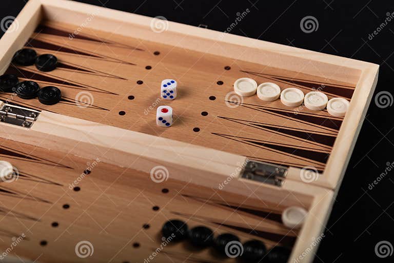 Board for Playing Backgammon with Pieces and Dice on a Black Background ...