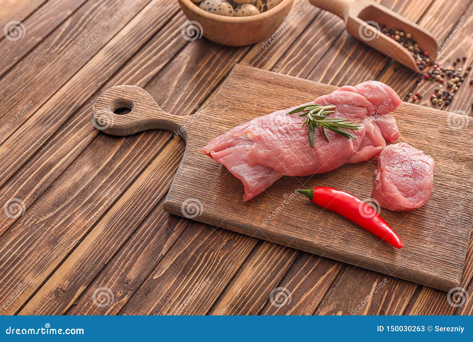 Board with Raw Pork Tenderloin on Kitchen Table. Fresh Meat Products ...