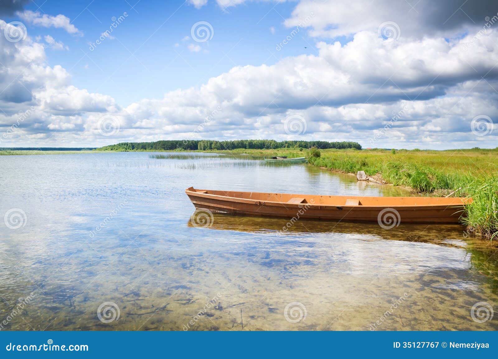 Boat on the bank of lake stock image. Image of grass - 35127767
