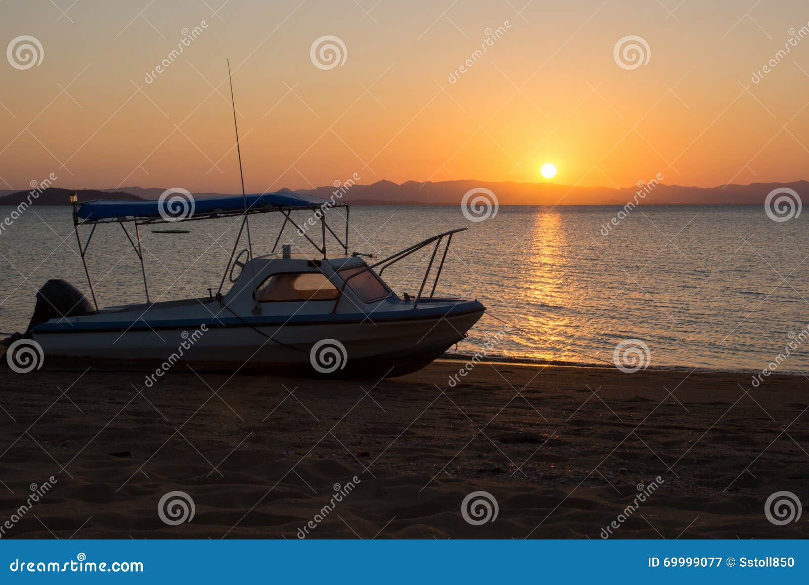 Boat on beach at sunset stock image. Image of coastline - 69999077