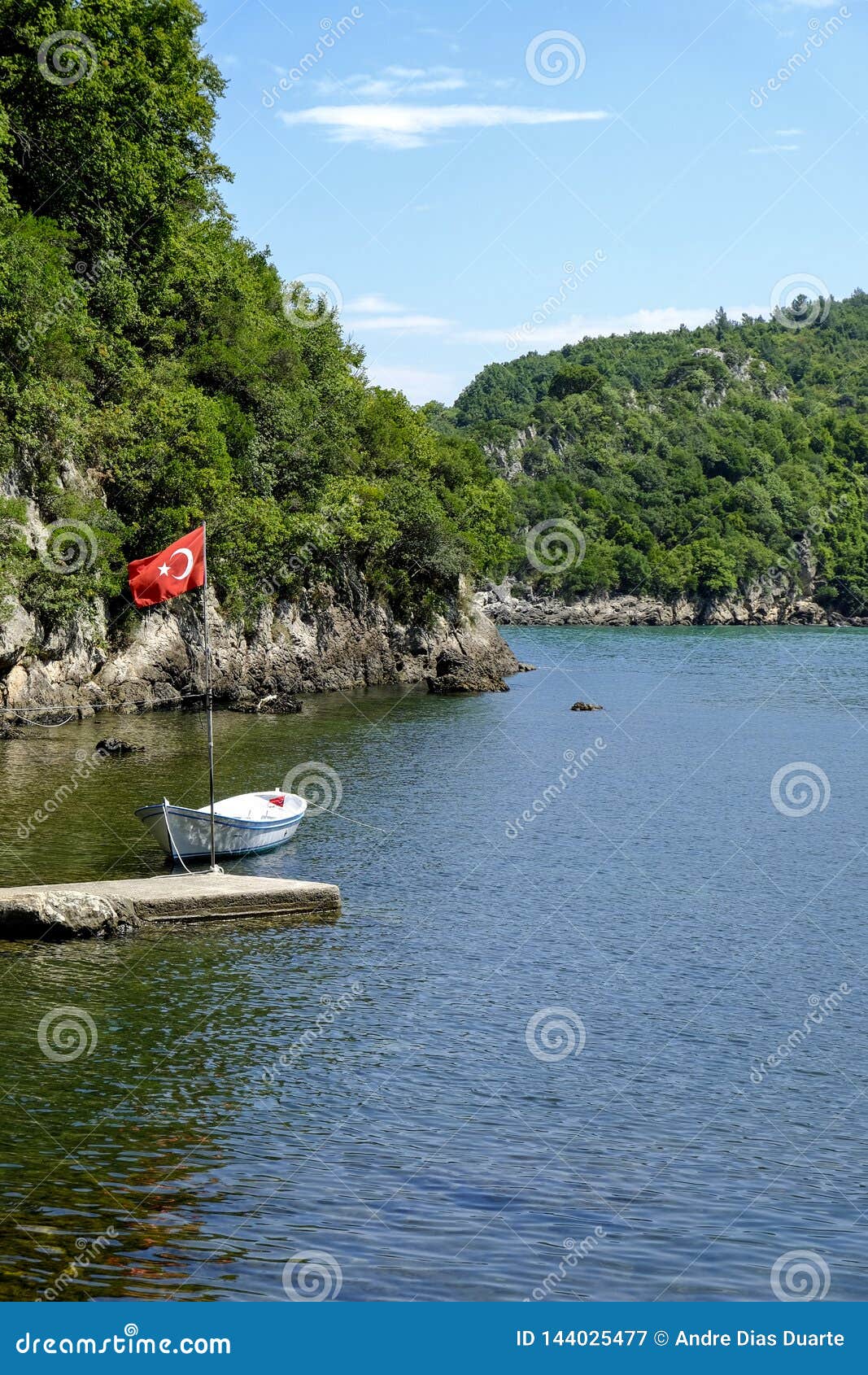 Boat docked in a cove stock image. Image of clouds, island - 144025477