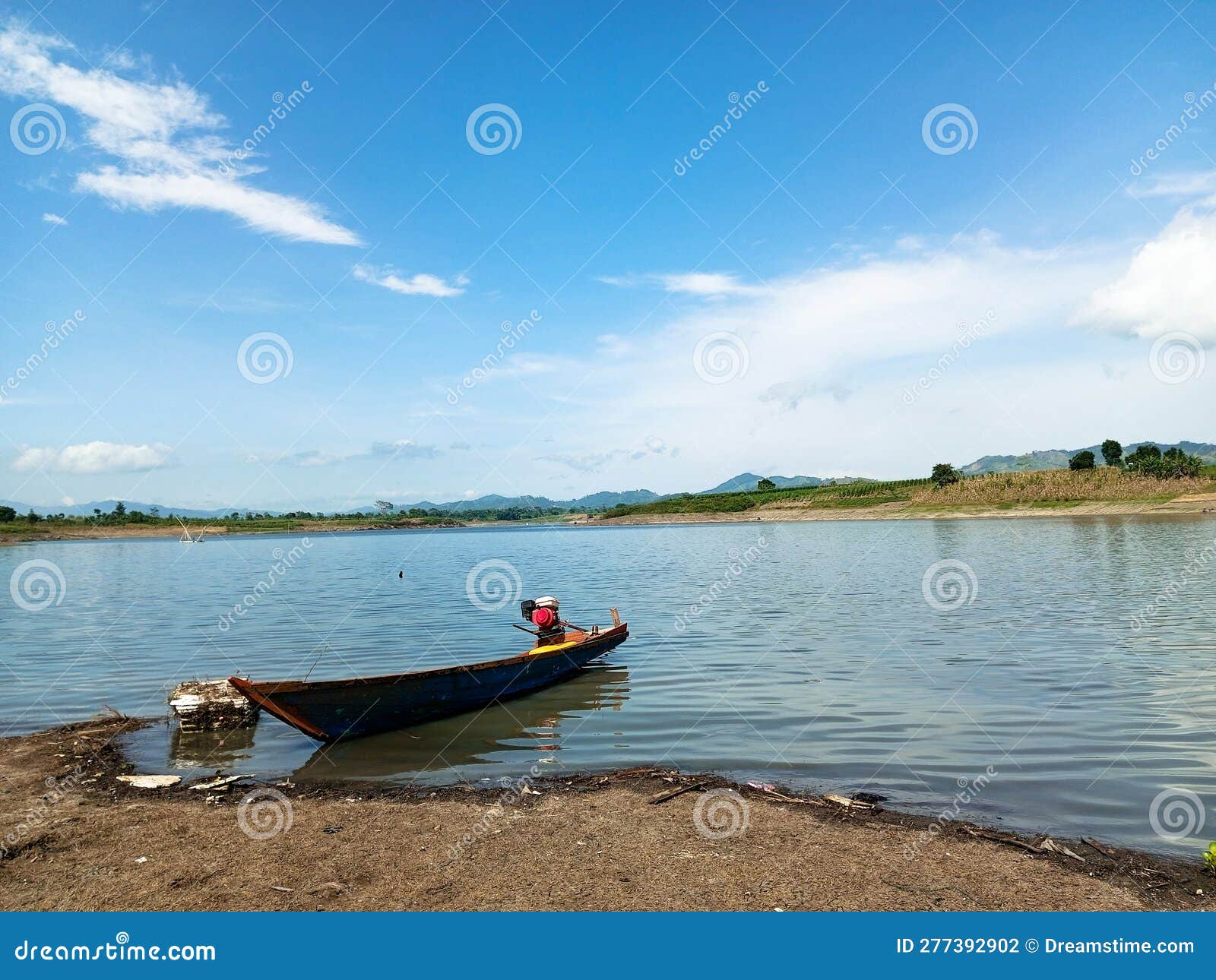A Boat on the Edge of a Lake with a Blue Sky Stock Photo - Image of ...