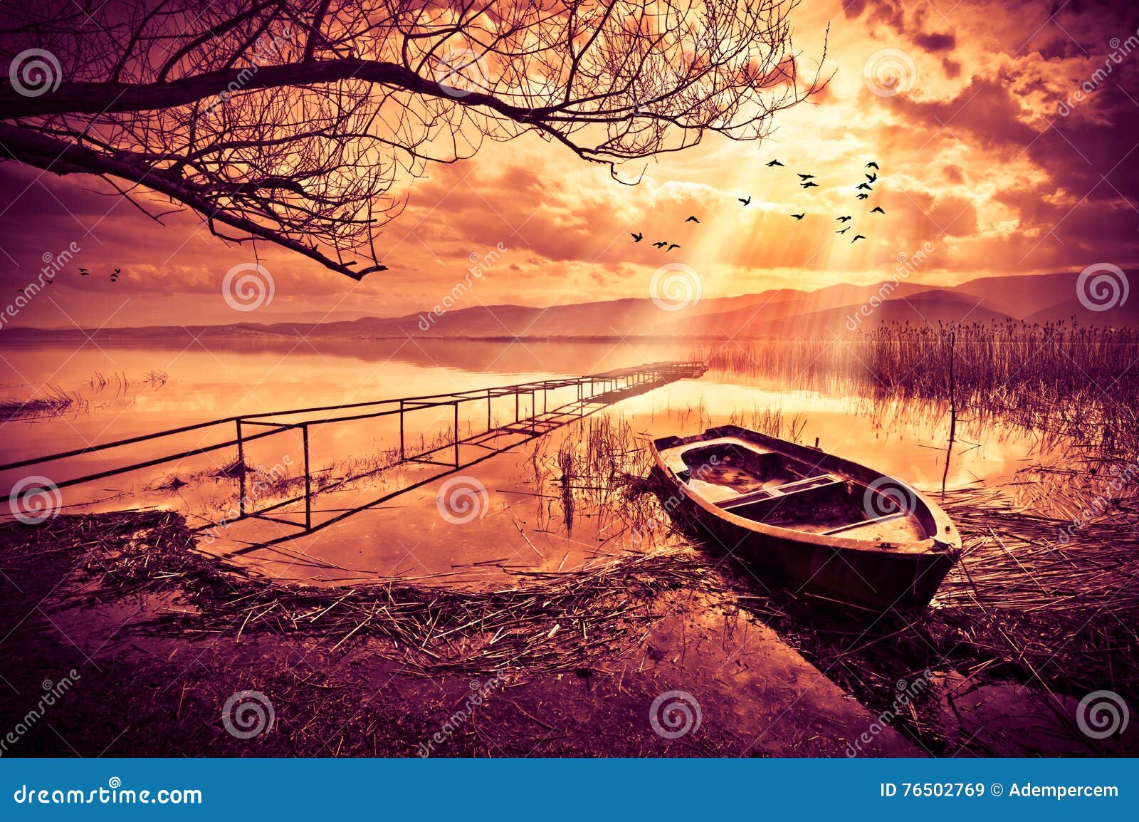 Boat on the lake at sunset stock image. Image of tranquil - 76502769