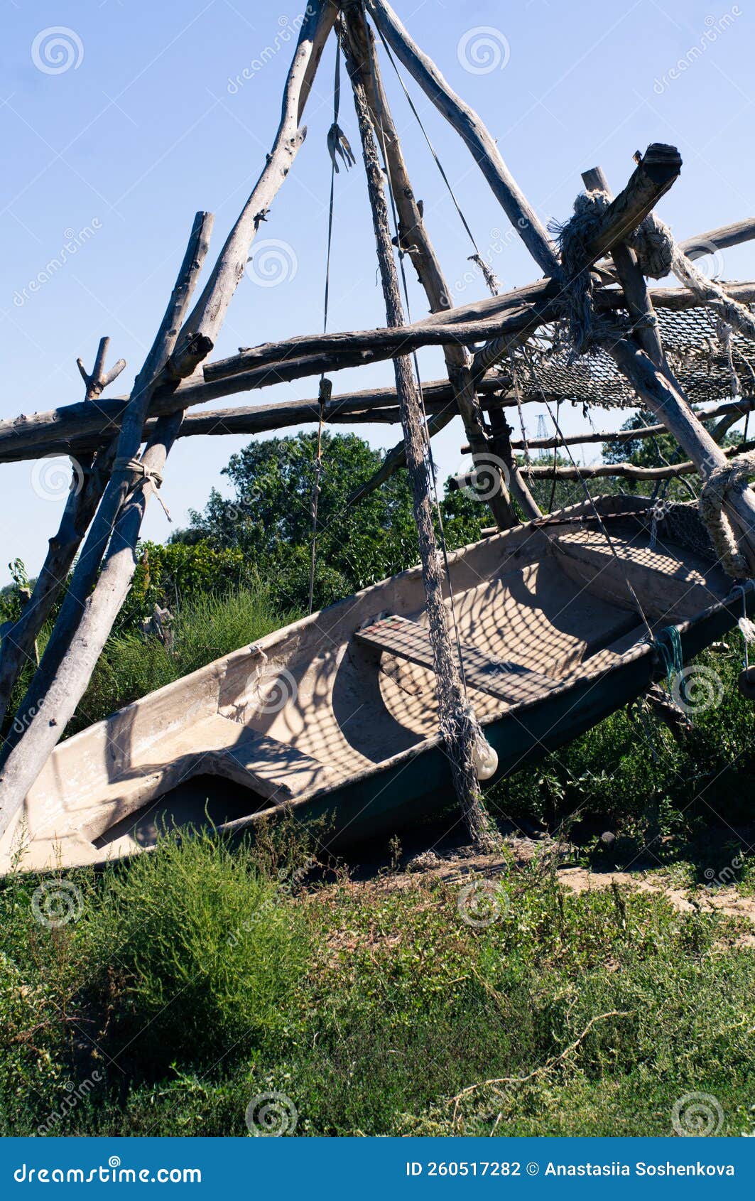 A Boat on Land is Suspended from Tree Trunks. Stock Photo - Image of ...