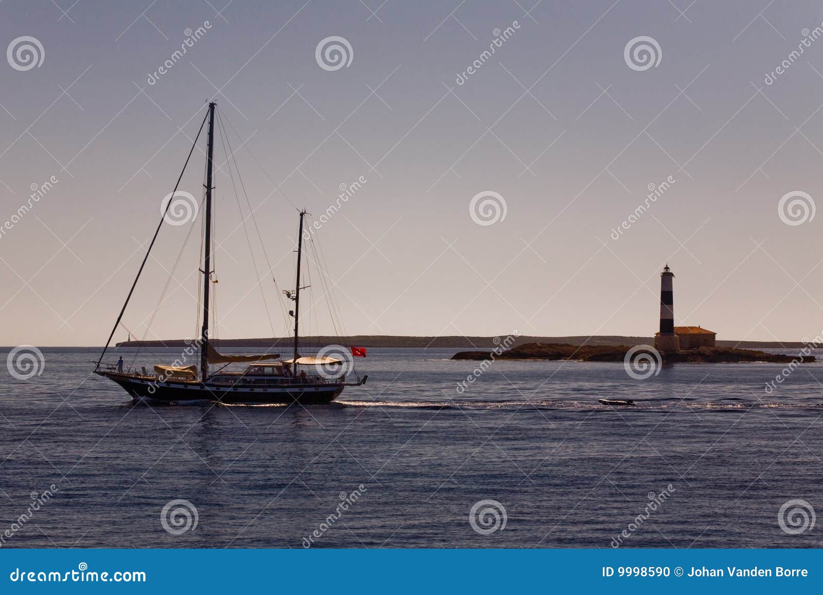 Boat and Lighthouse at Sunset Stock Photo - Image of floating ...