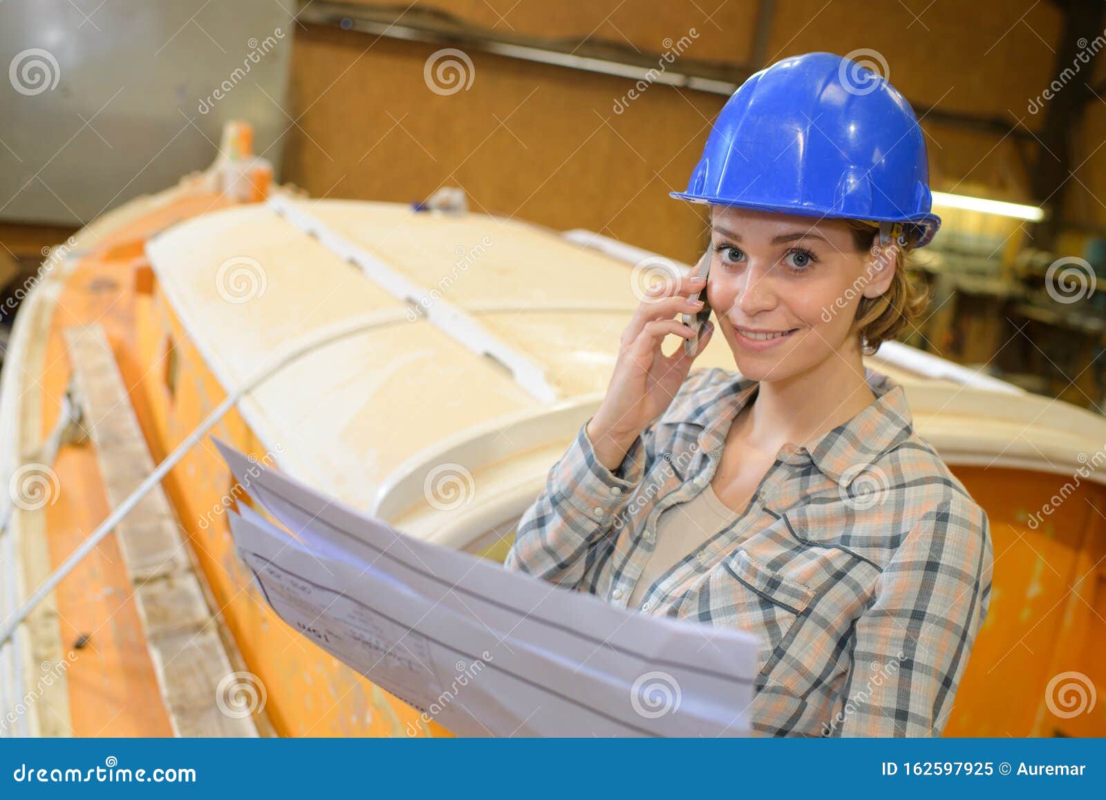 Boat Mechanic Smiling while Using Phone at Garage Stock Image - Image ...