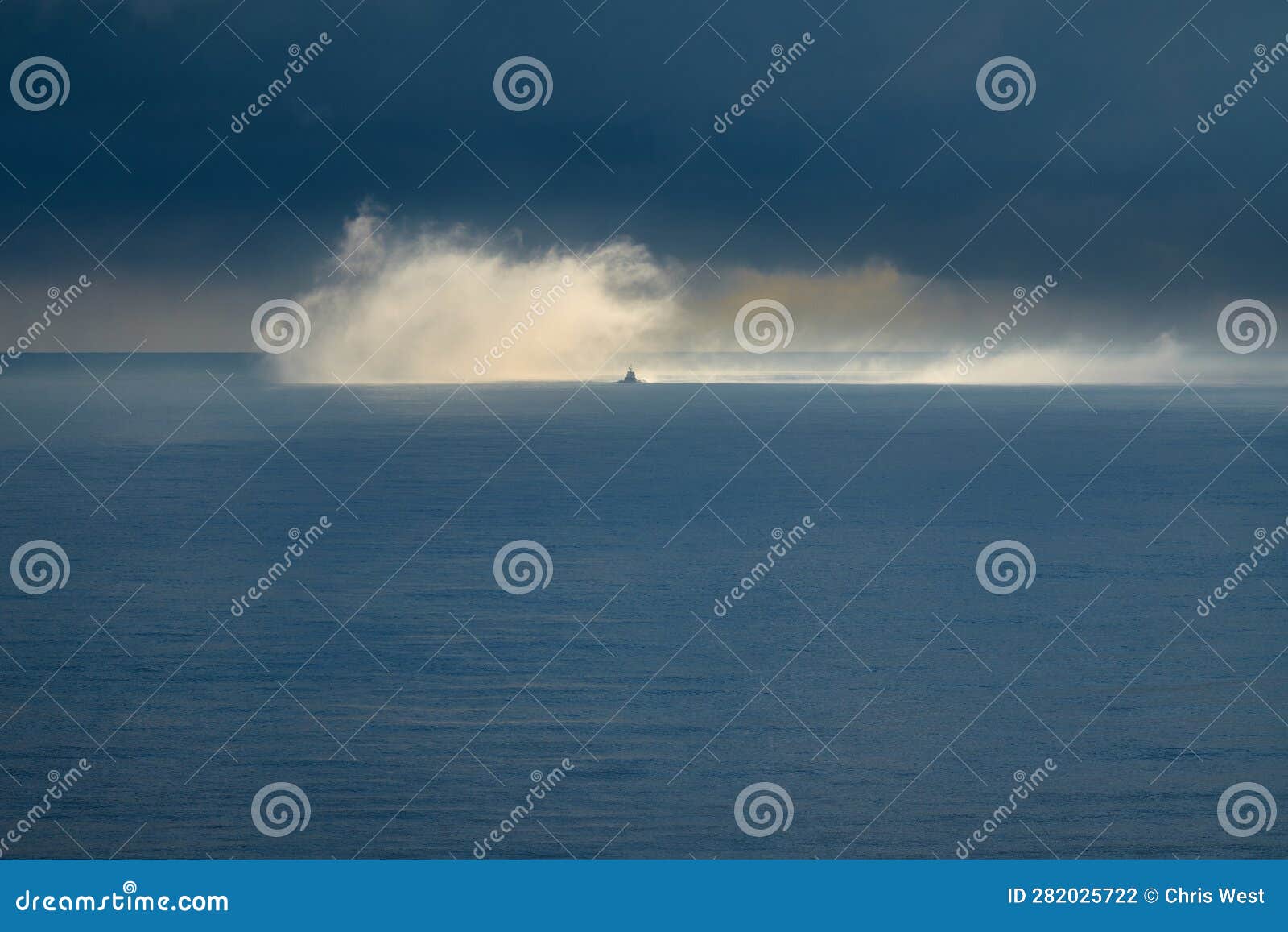 A Boat on the Ocean Emerges from a Cloud of Mist on the Ocean Stock ...