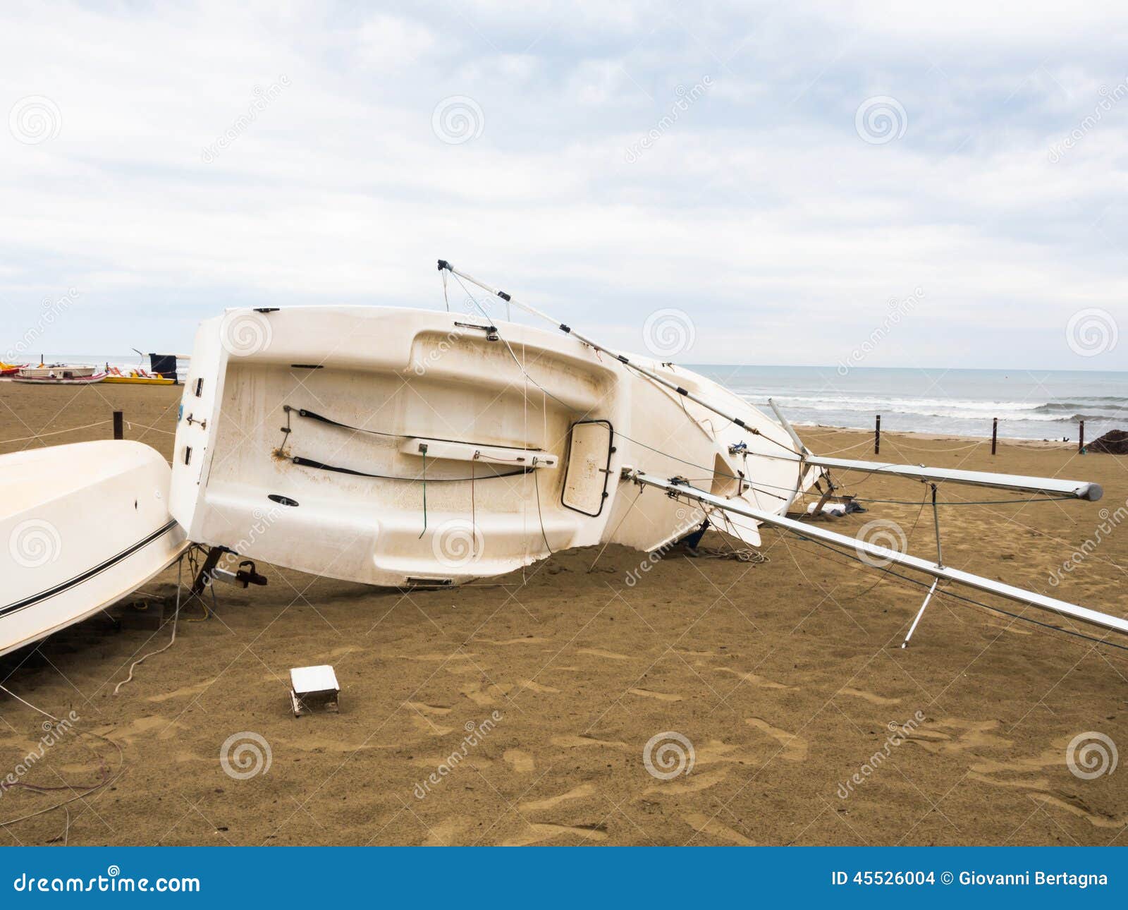 The Boat Overturned on the Beach Stock Photo - Image of boat, blue ...