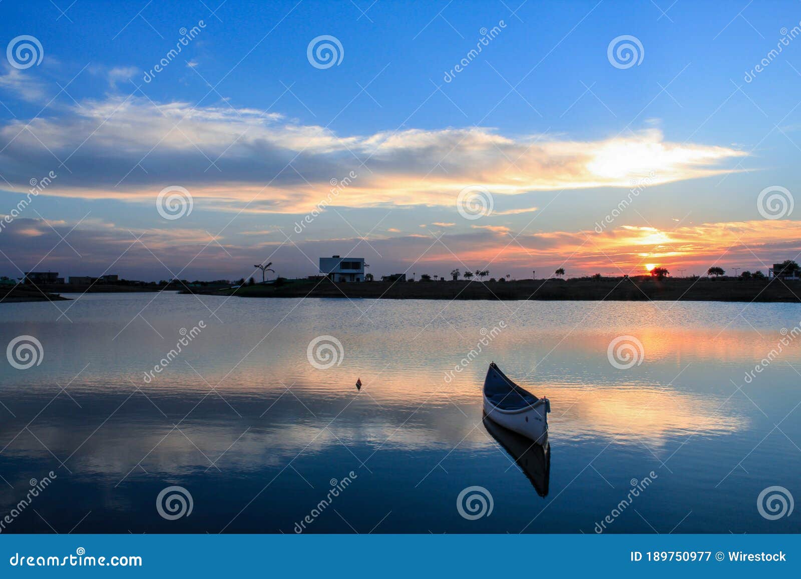 Boat on the River Gleaming Under the Sunset Piercing through the Clouds ...