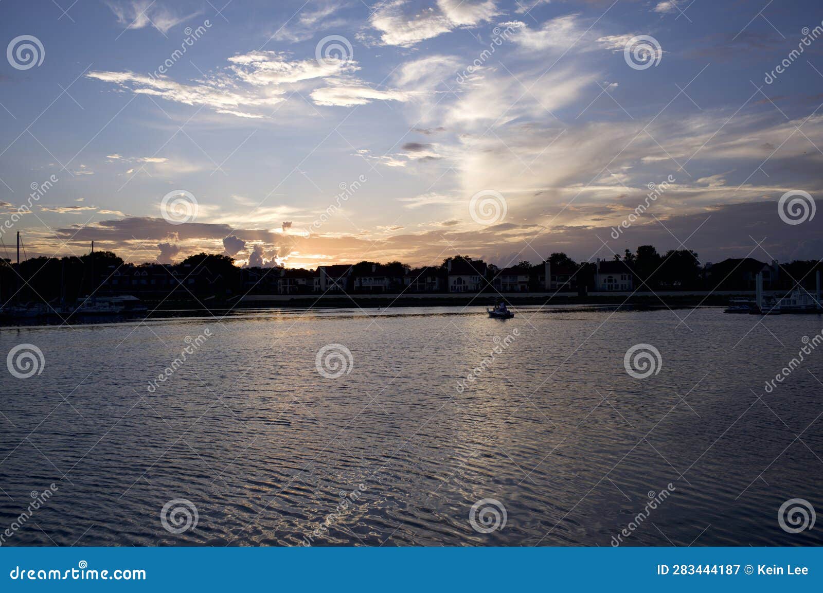 A Boat Sailing into the Distance Connected with Sunset Lights. Stock ...