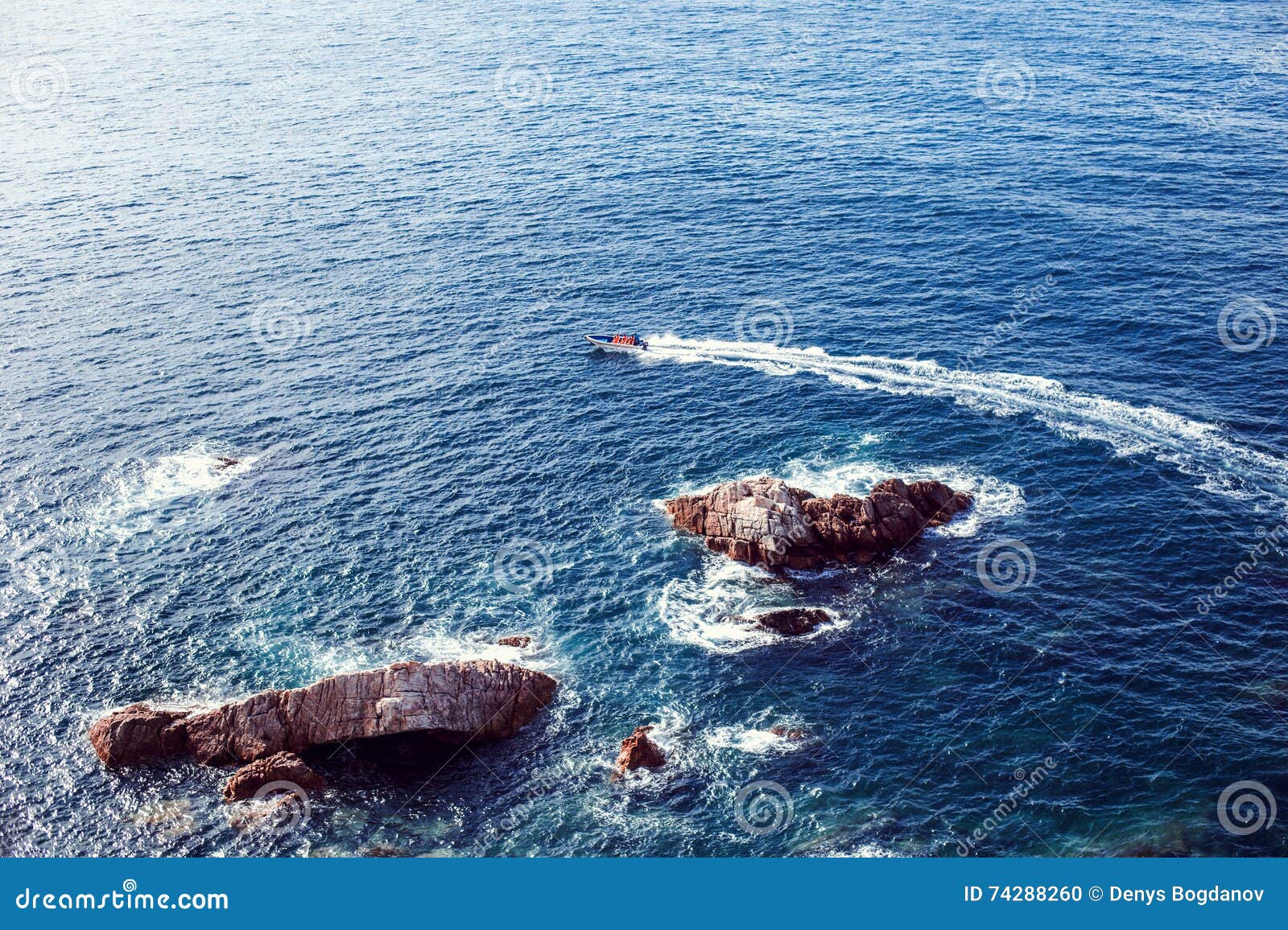Boat Sails Near the Rocks in the Water and Reserve the Water Path ...