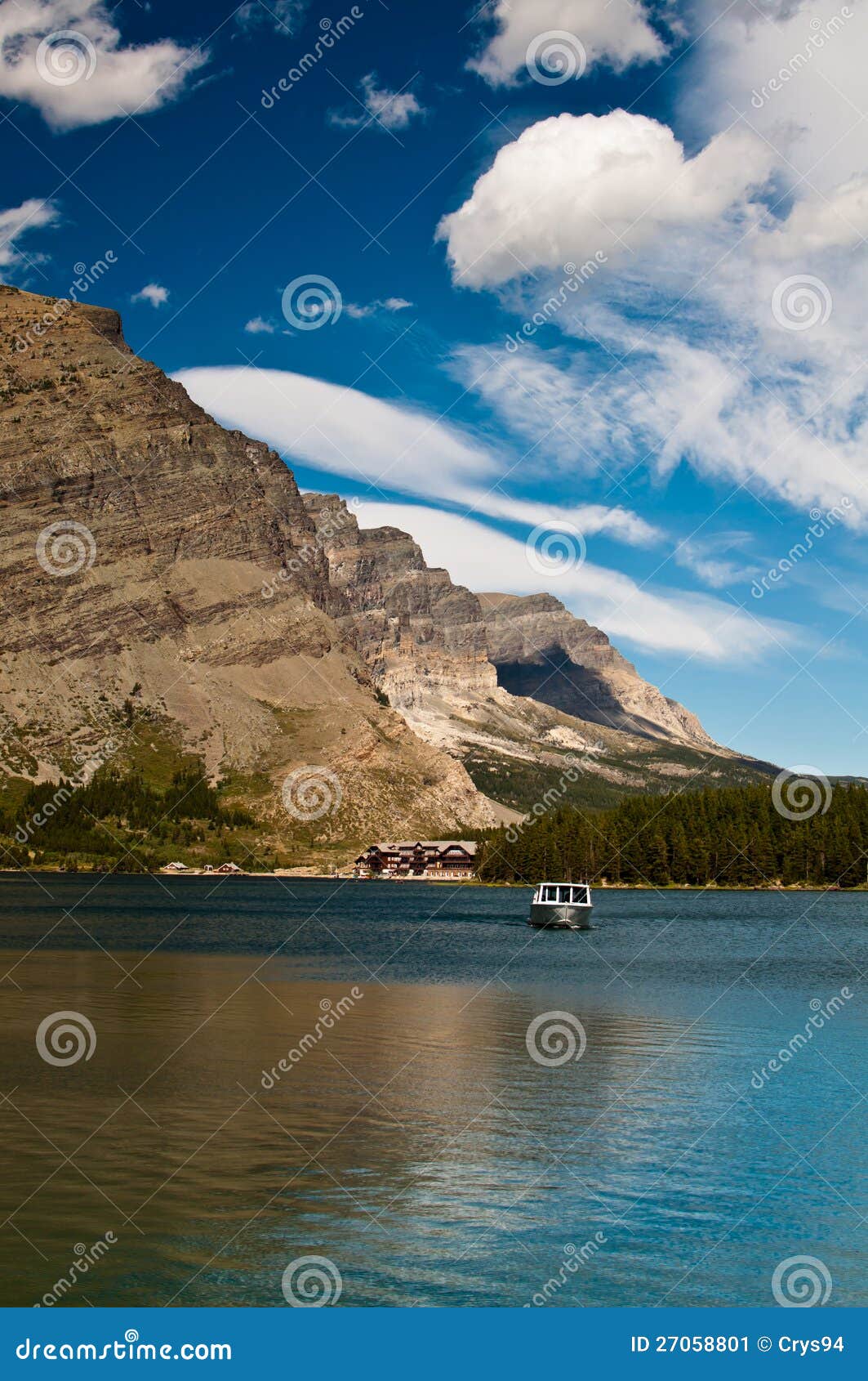Boat on Swiftcurrent Lake stock image. Image of mountains - 27058801
