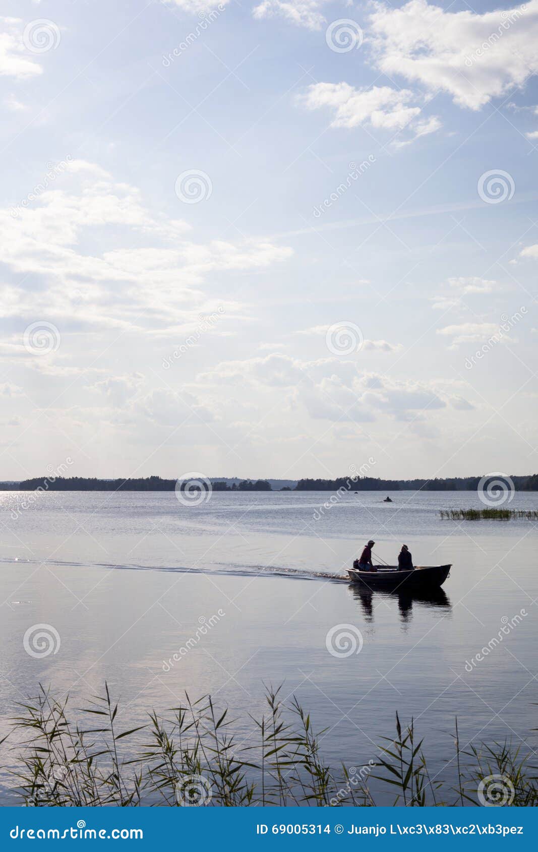Boat with Two People Sailing on a Lake at Sunset Stock Photo - Image of ...