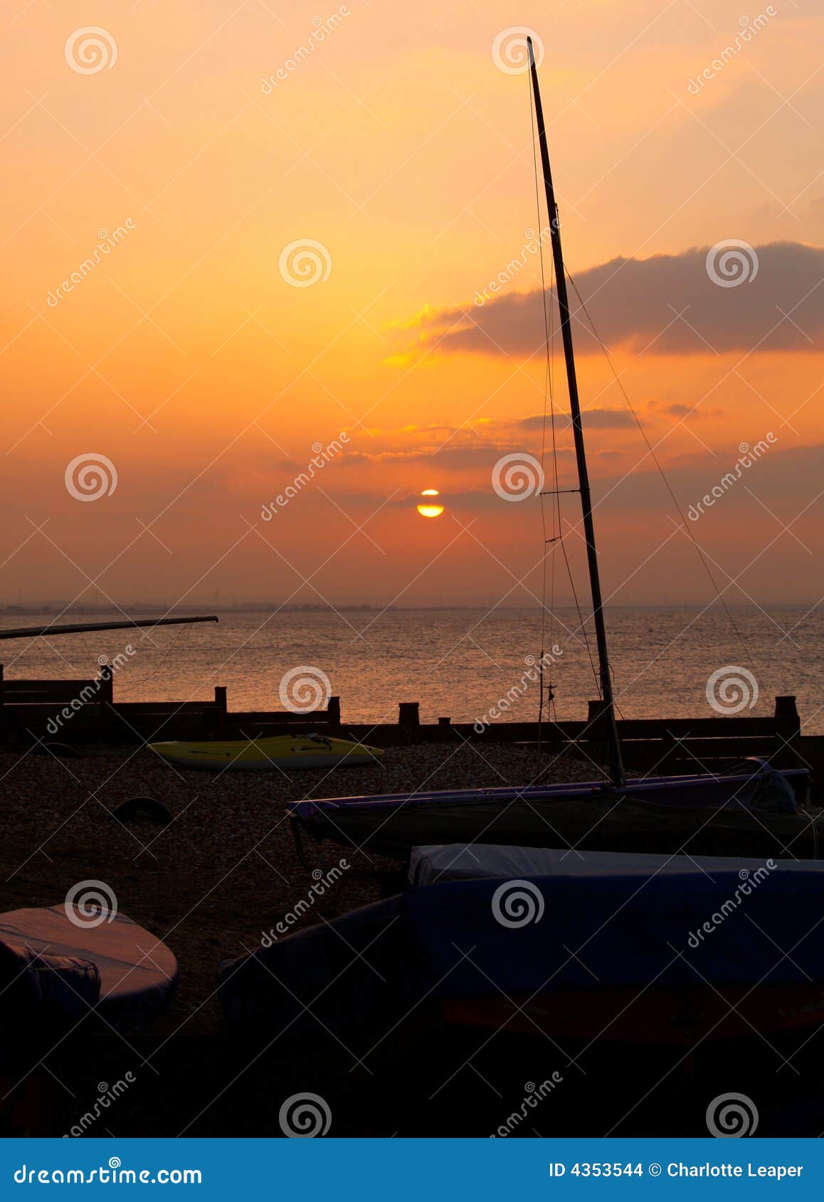 Boats on beach at sunset stock photo. Image of outdoors - 4353544