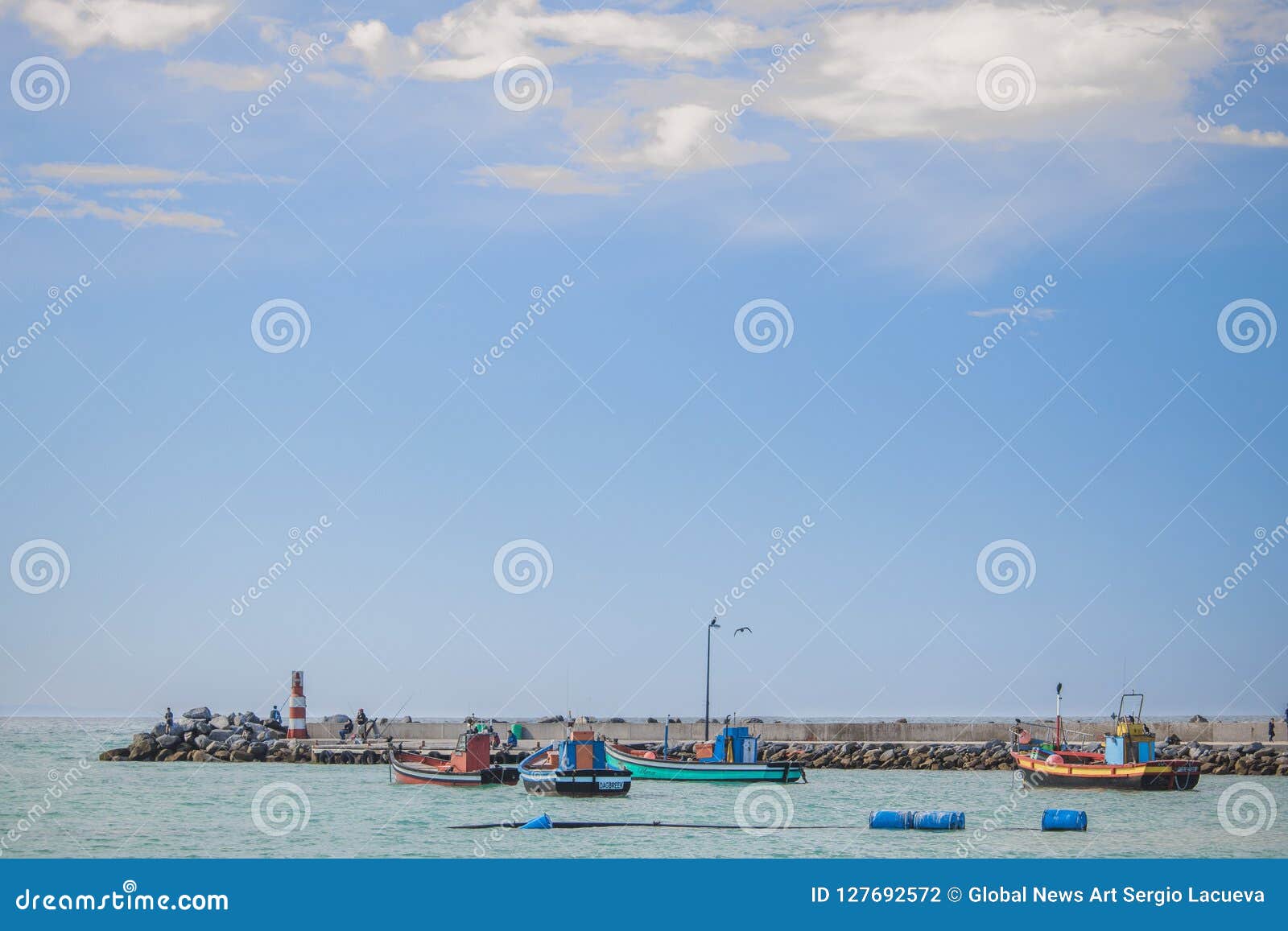 Boats in a Harbor with Turquoise Water and Peer in the Background ...