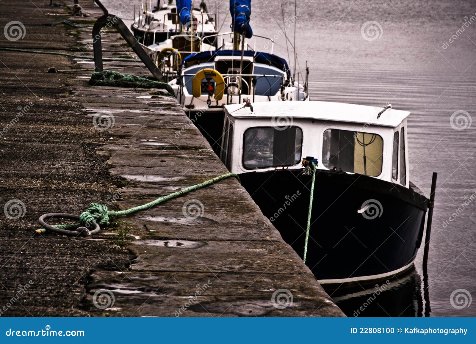 Boats tied to a Stone Dock stock photo. Image of dusk - 22808100