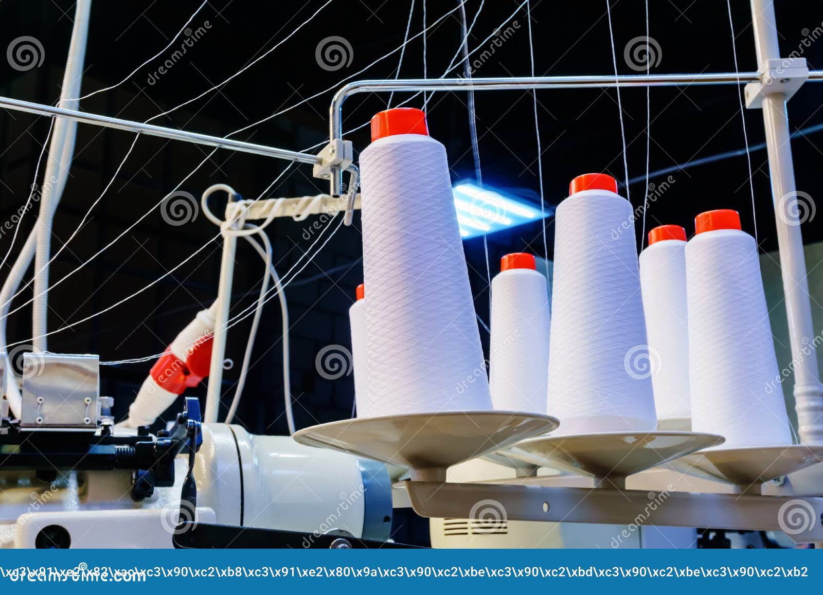 Bobbins with White Threads Secured in an Industrial Sewing Machine ...