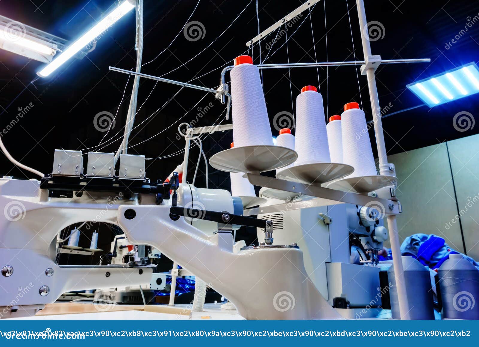 Bobbins with White Threads Secured in an Industrial Sewing Machine ...