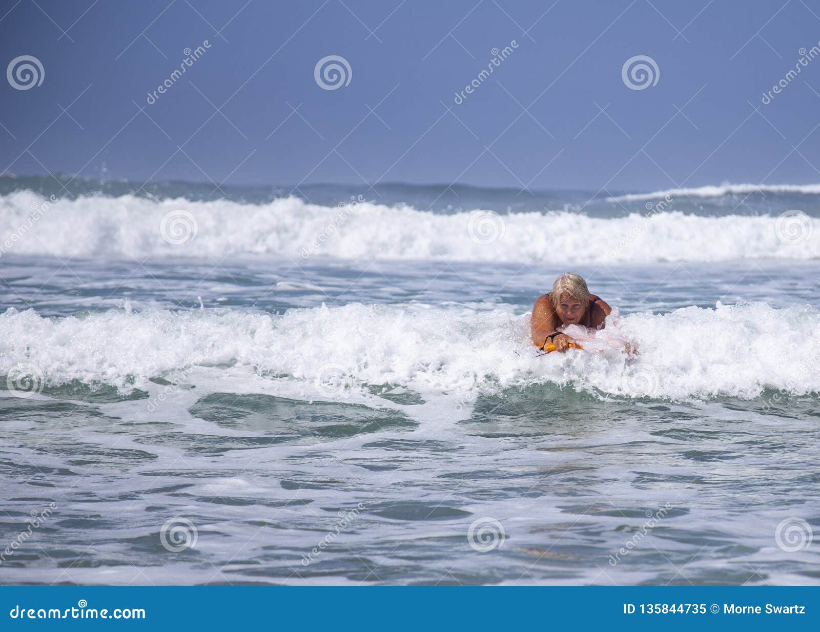 Elderly Woman Bodyboarding stock image. Image of surfing - 135844735