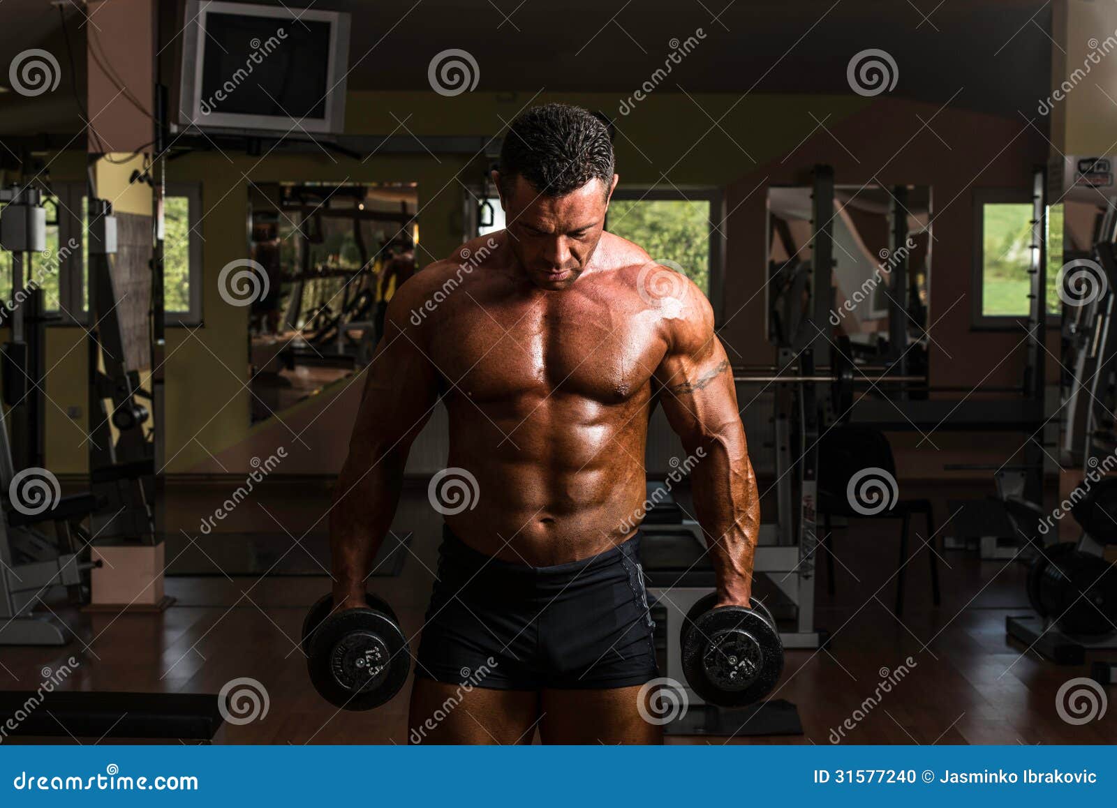 Body Builder Doing Heavy Weight Exercise for Biceps with Dumbbell Stock ...