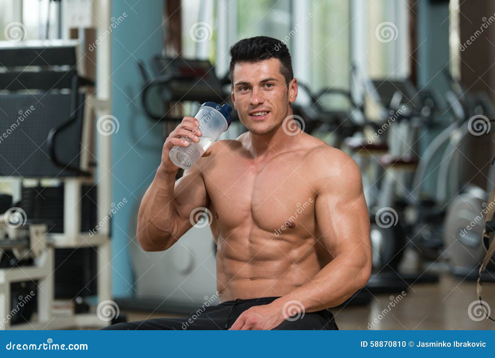 Body Builder Drinking Water from Shaker Stock Photo - Image of indoors ...