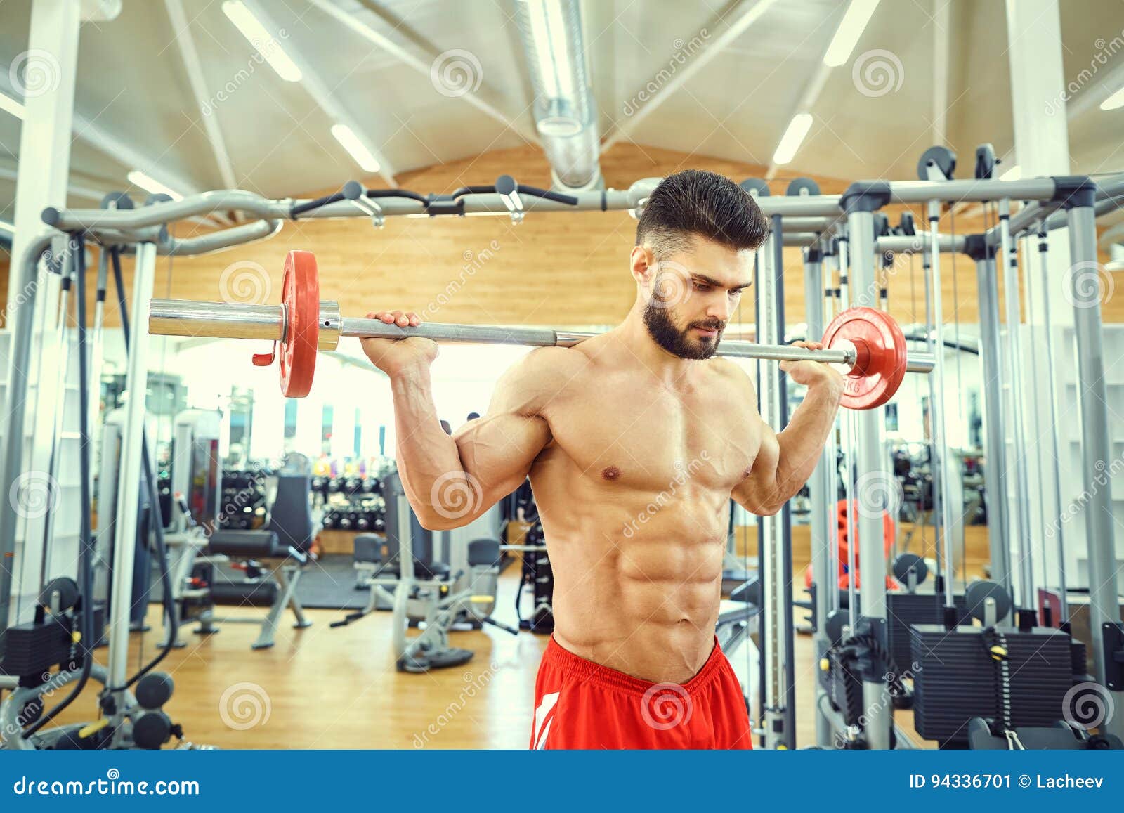 Bodybuilder with a Bar Barbell Makes Exercises in the Gym Stock Image ...