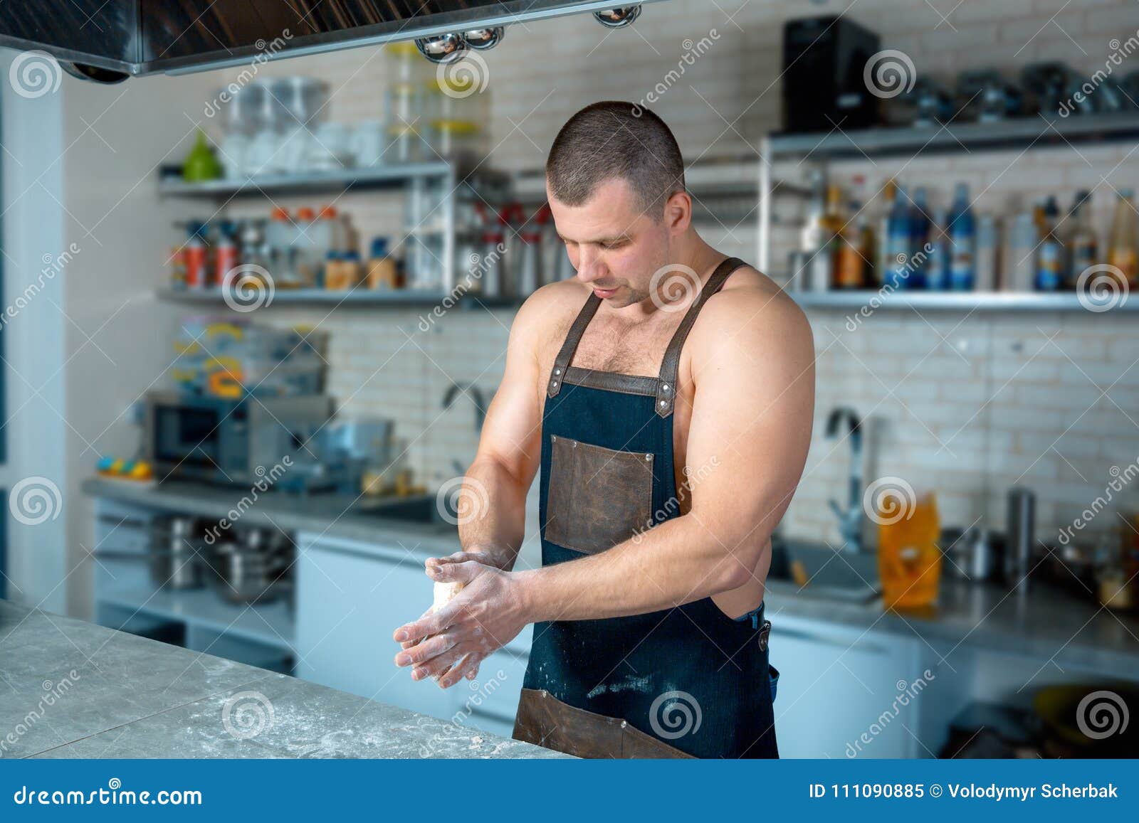Bodybuilder Chef in Hotel or Restaurant Kitchen Knead the Dough on the ...