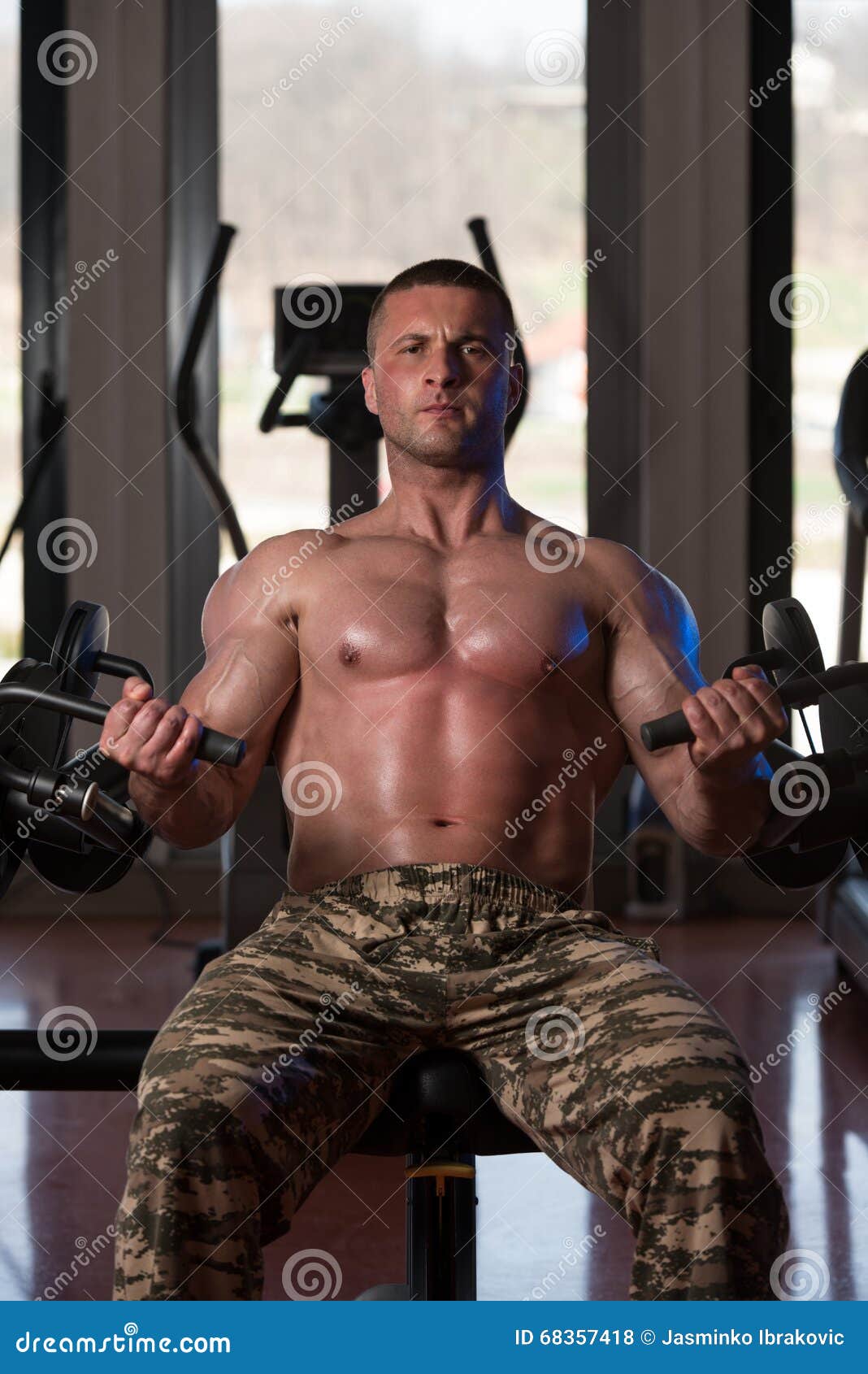 Bodybuilder Doing Exercise for Biceps with Machine Stock Photo - Image ...