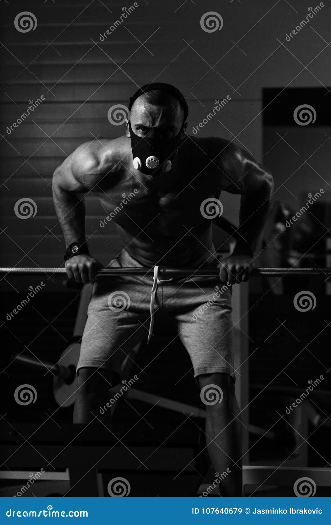 Bodybuilder Exercising Push-Ups on Barbell in Elevation Mask Stock ...