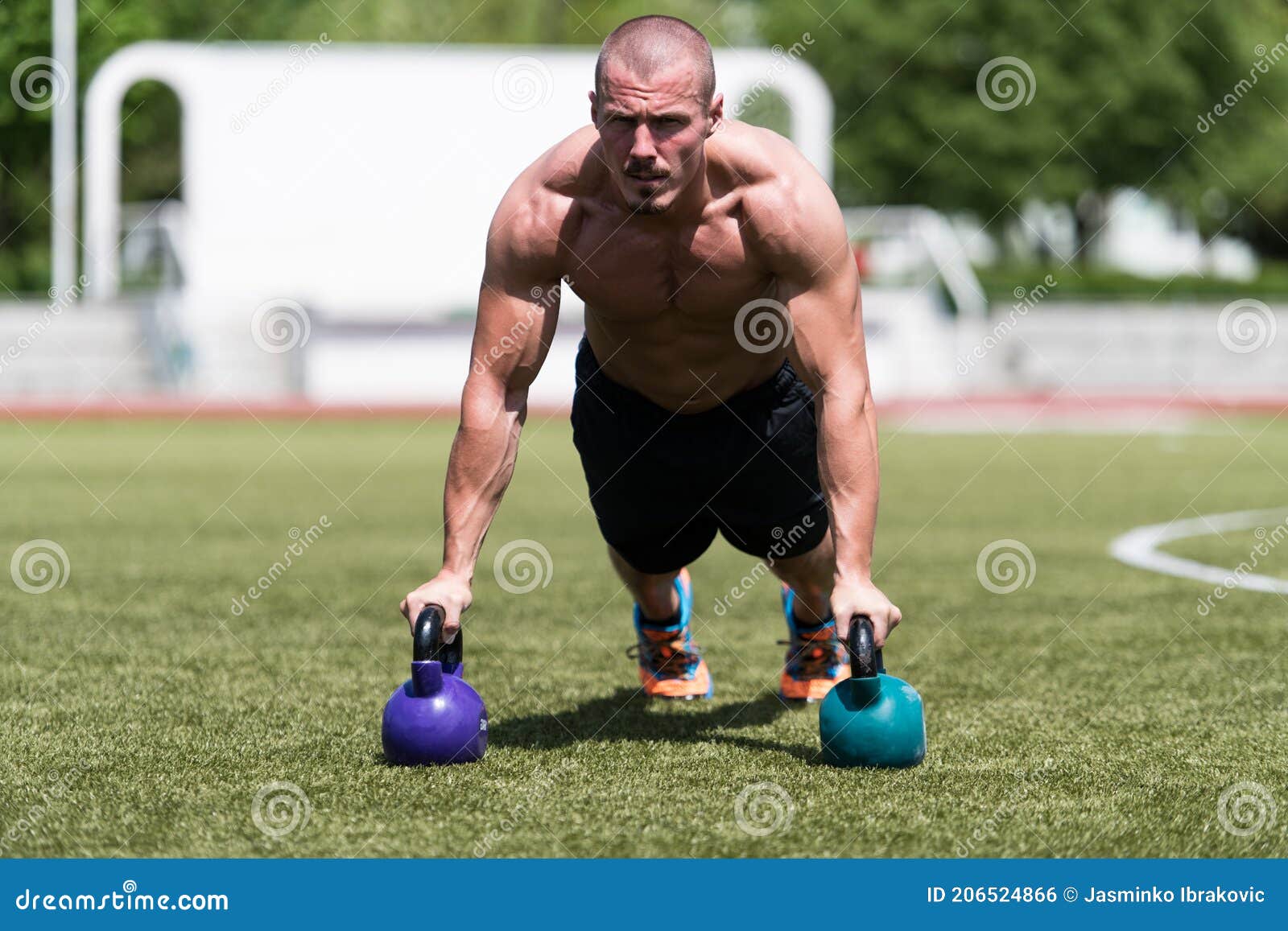 Bodybuilder Doing Push Ups on Grass with Kettle-bell Stock Photo ...