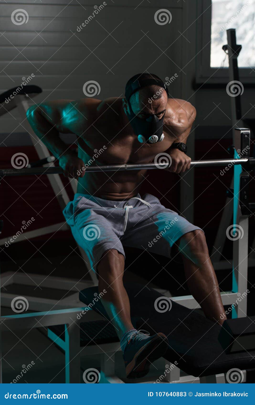 Bodybuilder Exercising Push-Ups on Barbell in Elevation Mask Stock ...